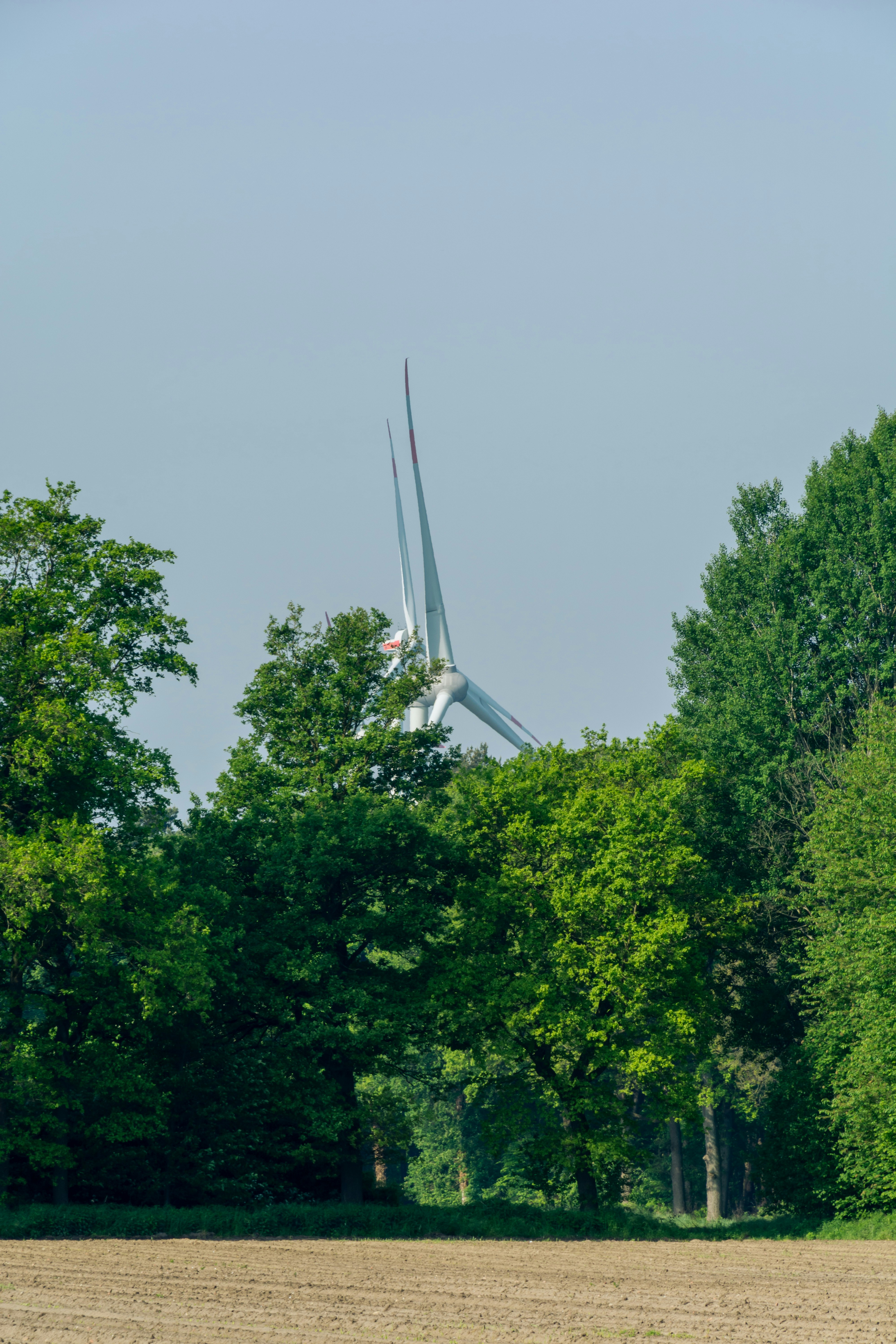 Wind Turbine Pierces the Sky Above a Quiet Field