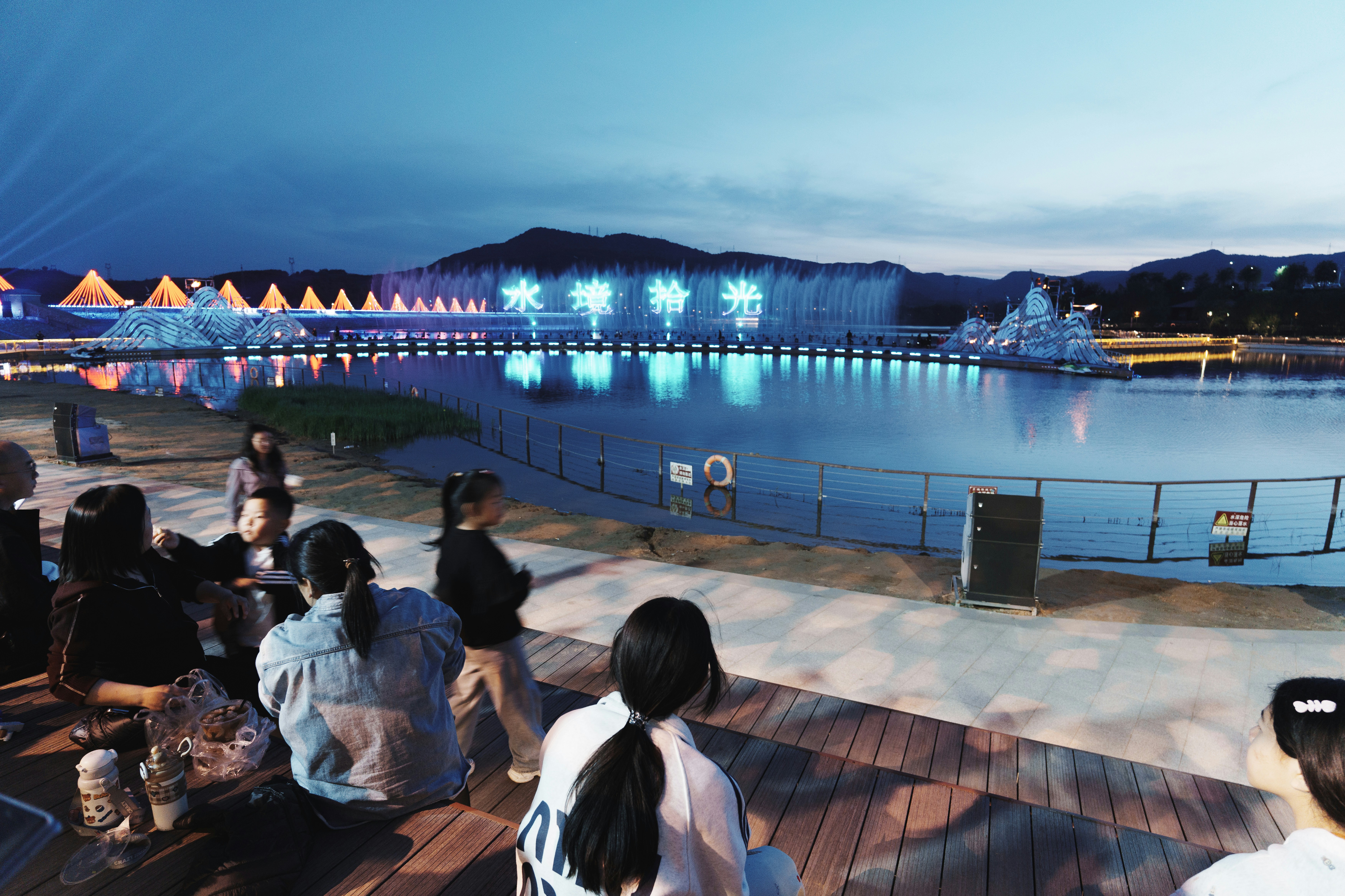 Ice Playground by Night: Lit Ice Sculptures Reflect on a Calm Lake