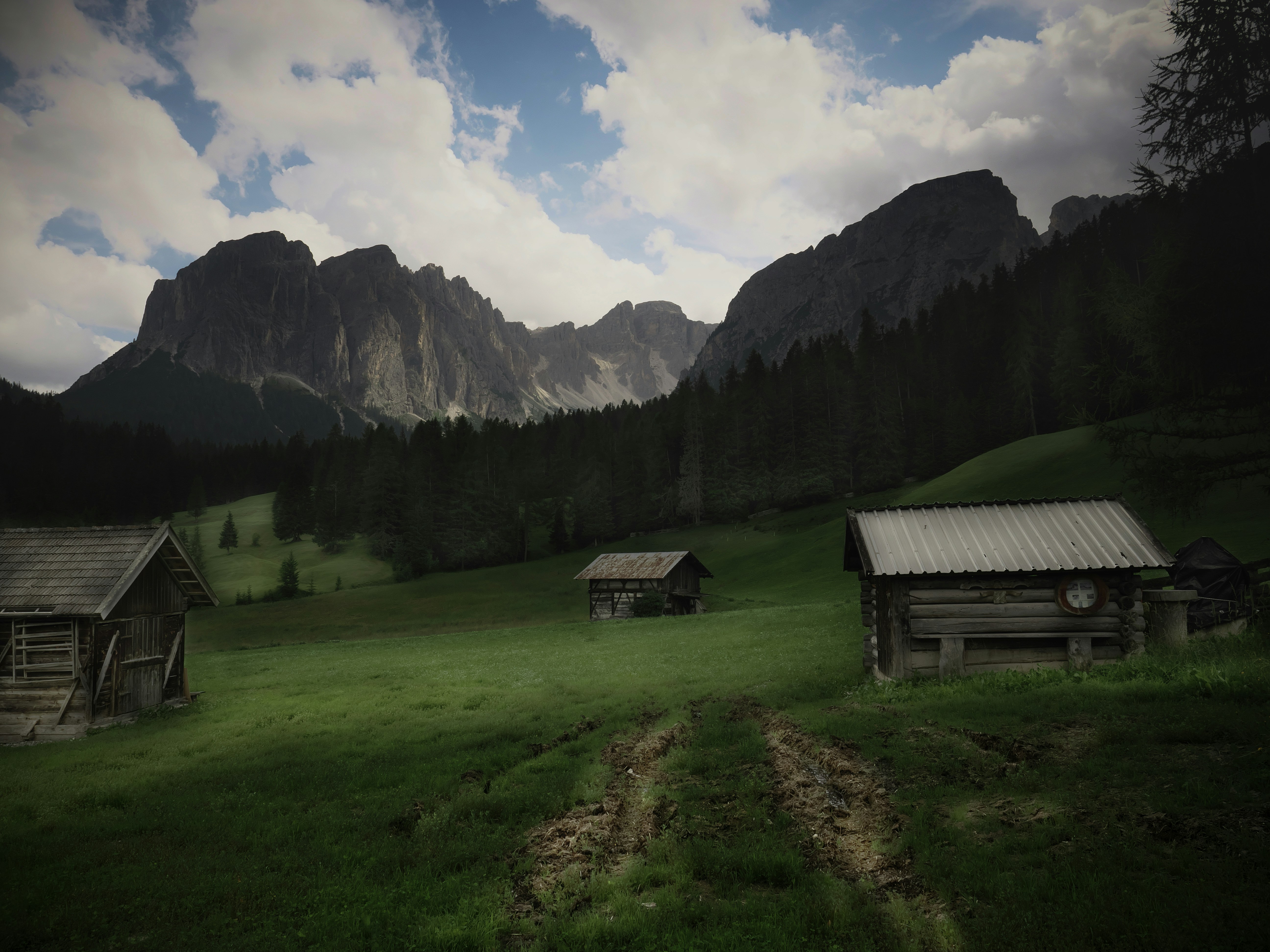 Azure Valley: Mountain Vistas Behind Weathered Cabins