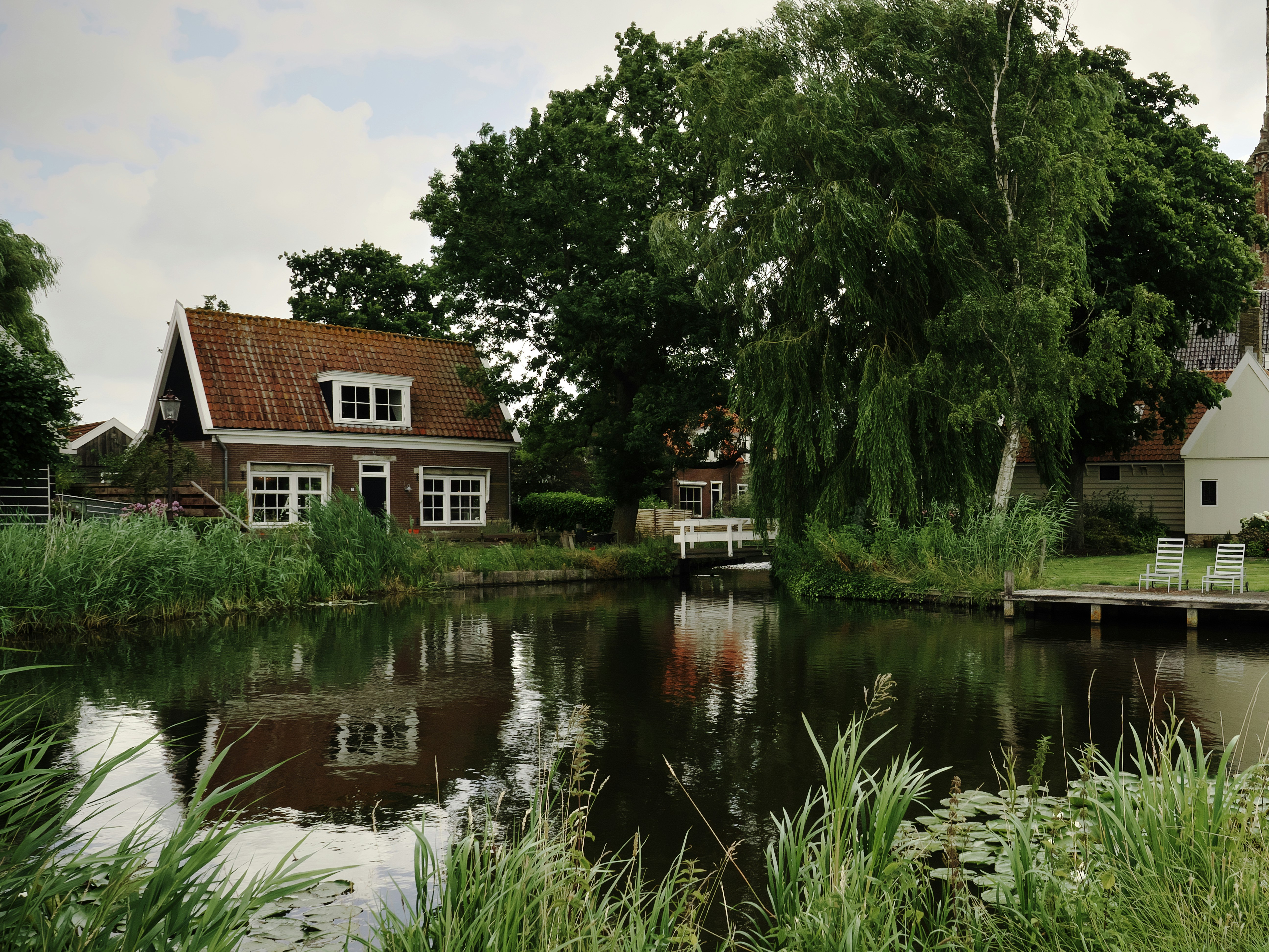 Waterfront Village at Dusk: A Quiet Canal Between Red-Tiled Homes