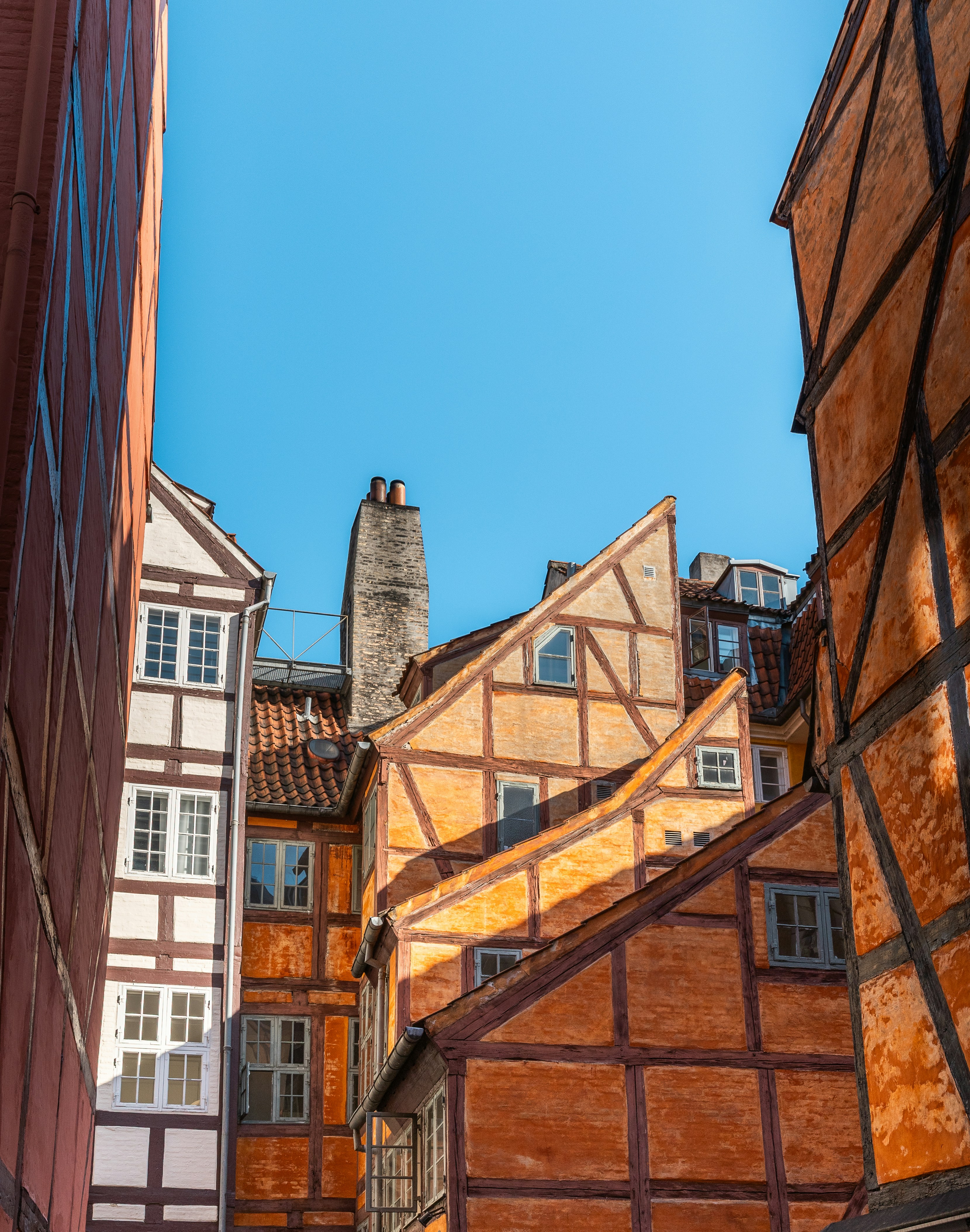 Sunlit Timber-Framed Townscape Rising toward a Clear Blue Sky