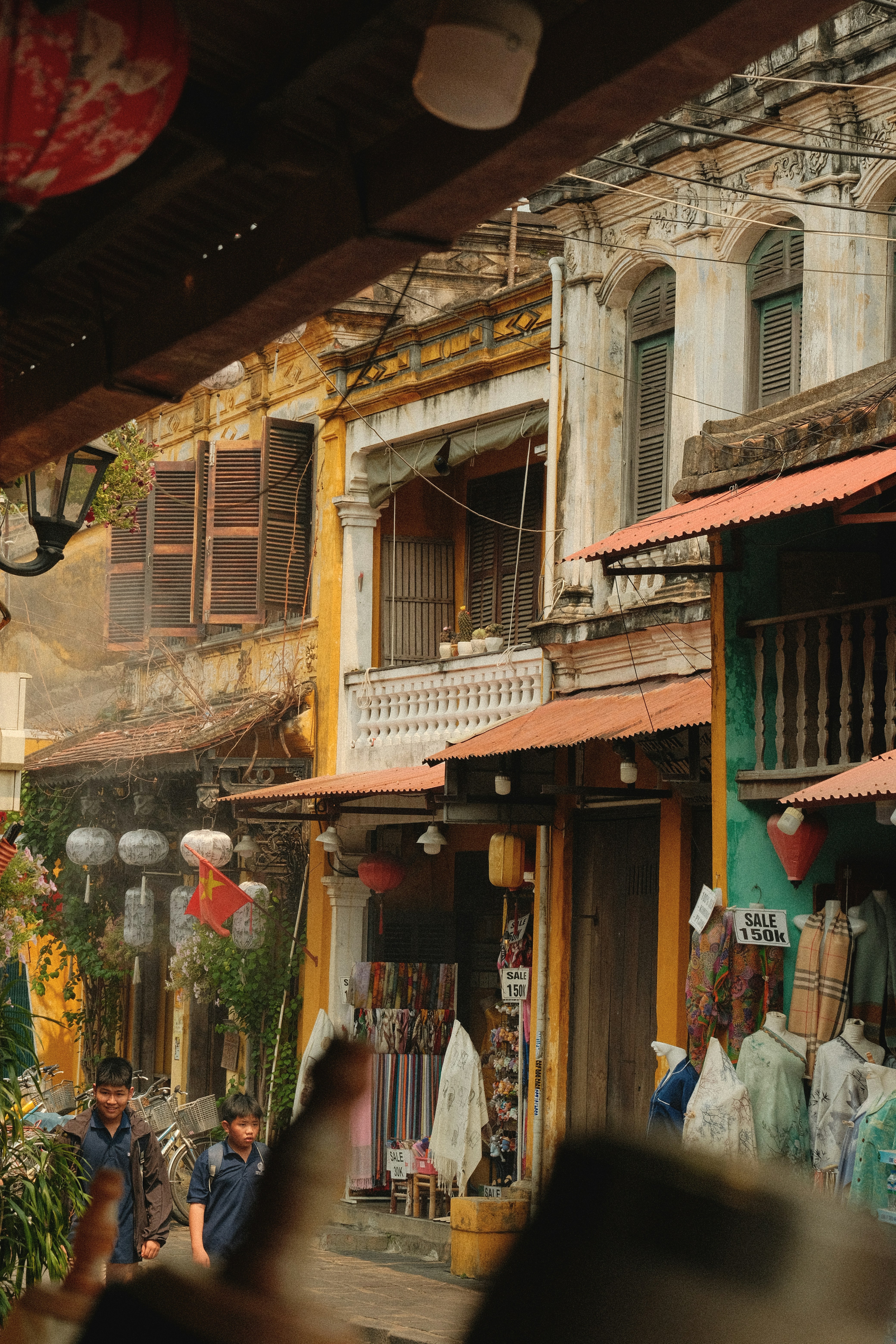 Colorful Canal Street: A Sunlit Market Corridor with Shuttered Balconies