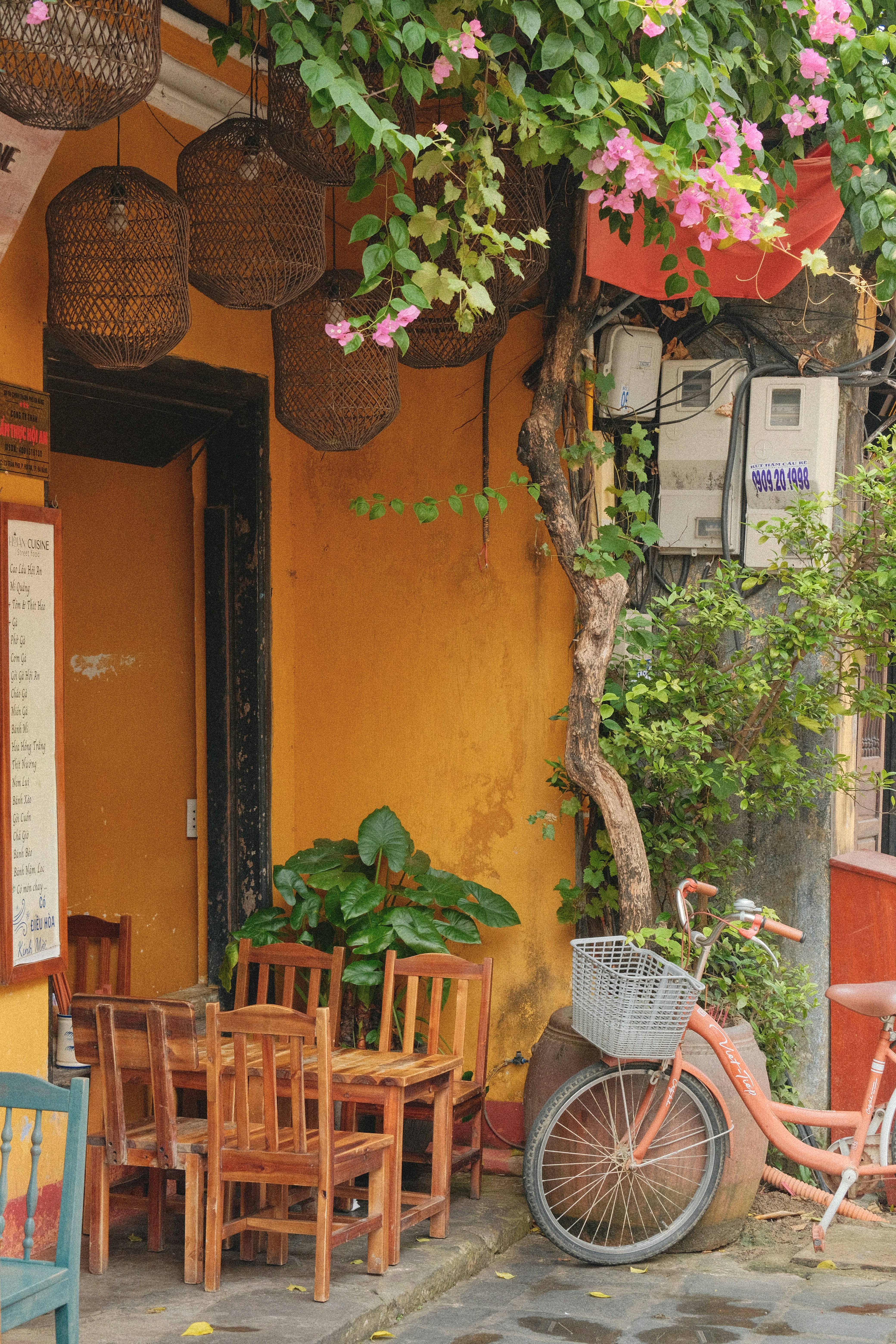 Courtyard Café: Warm Ochre Wall, Hanging Lamps and a Rusty Bicycle