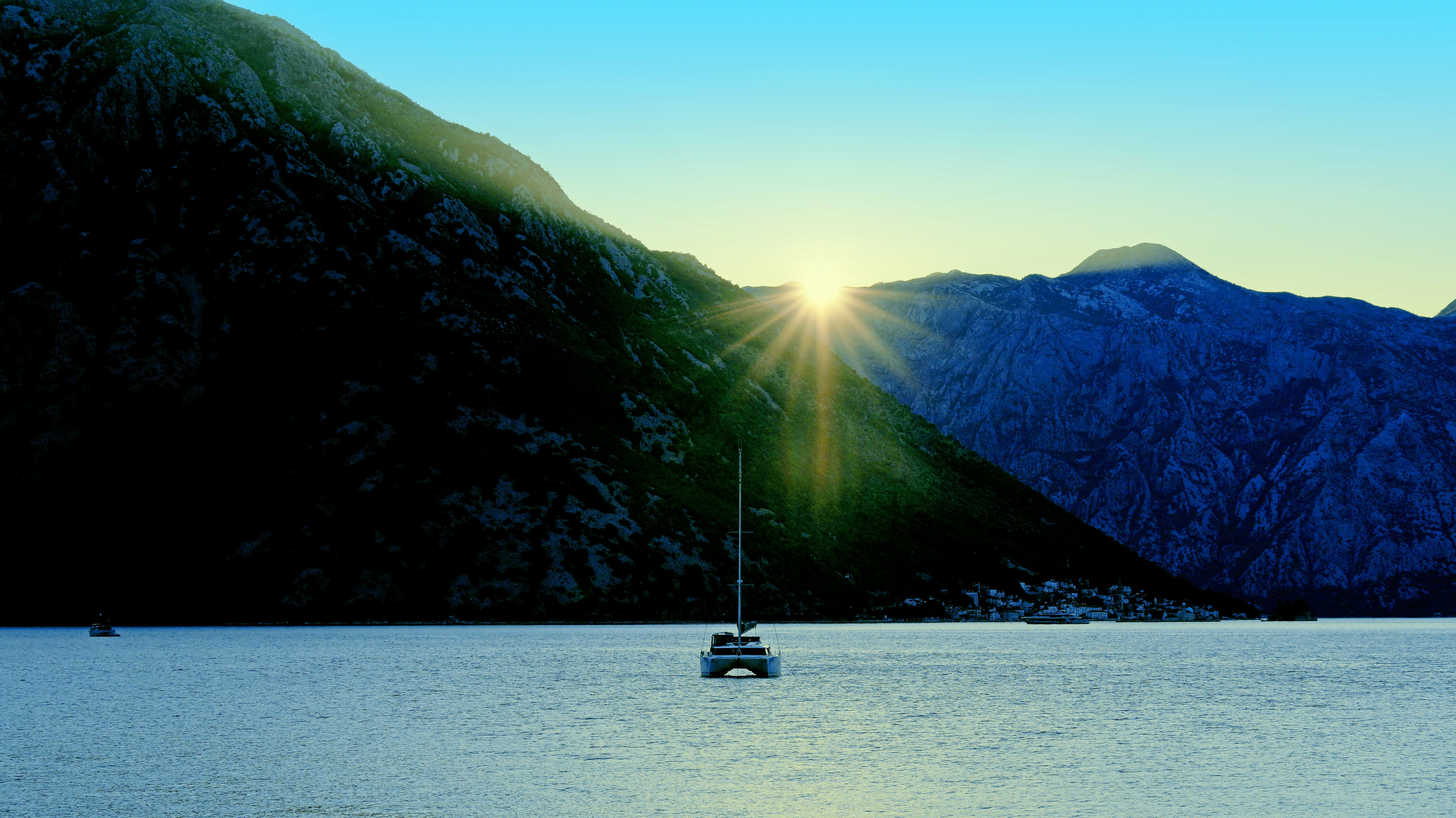 Sunrise Summit Over Quiet Fjord