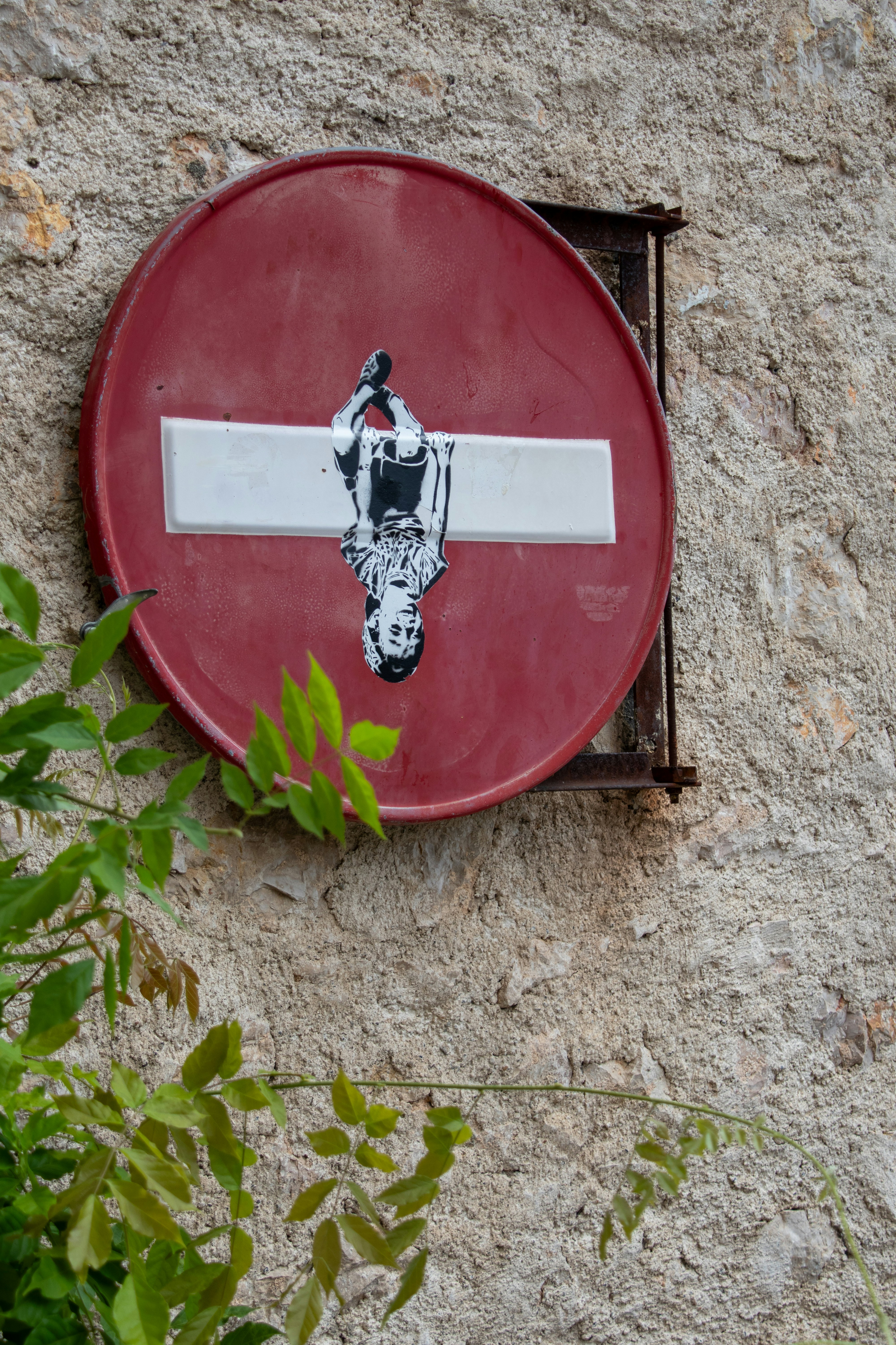 Upside-Down Stop Sign on a Rough Stone Wall