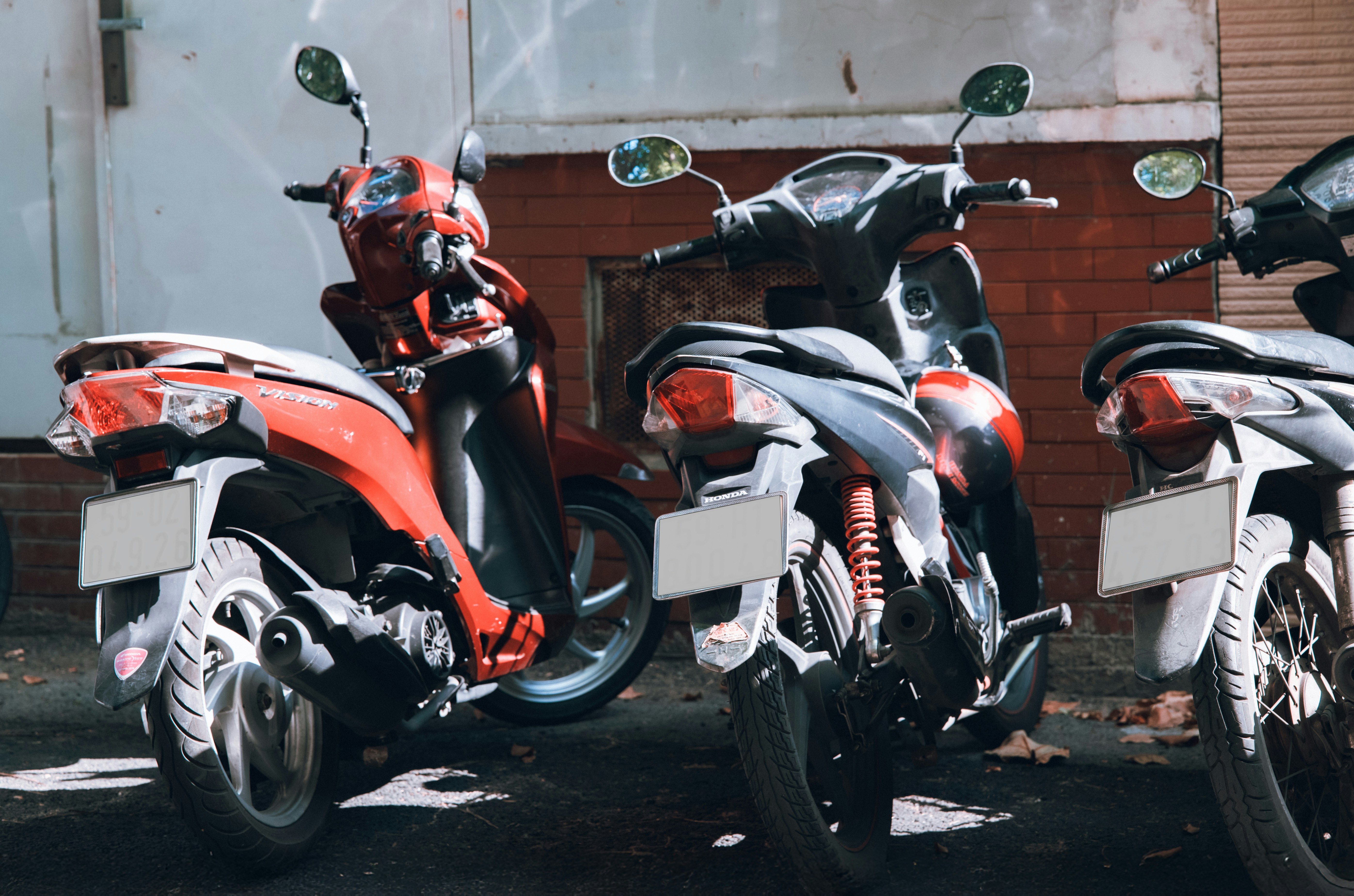 Tri-ride Gallery: Three scooters angled into a sunlit alley