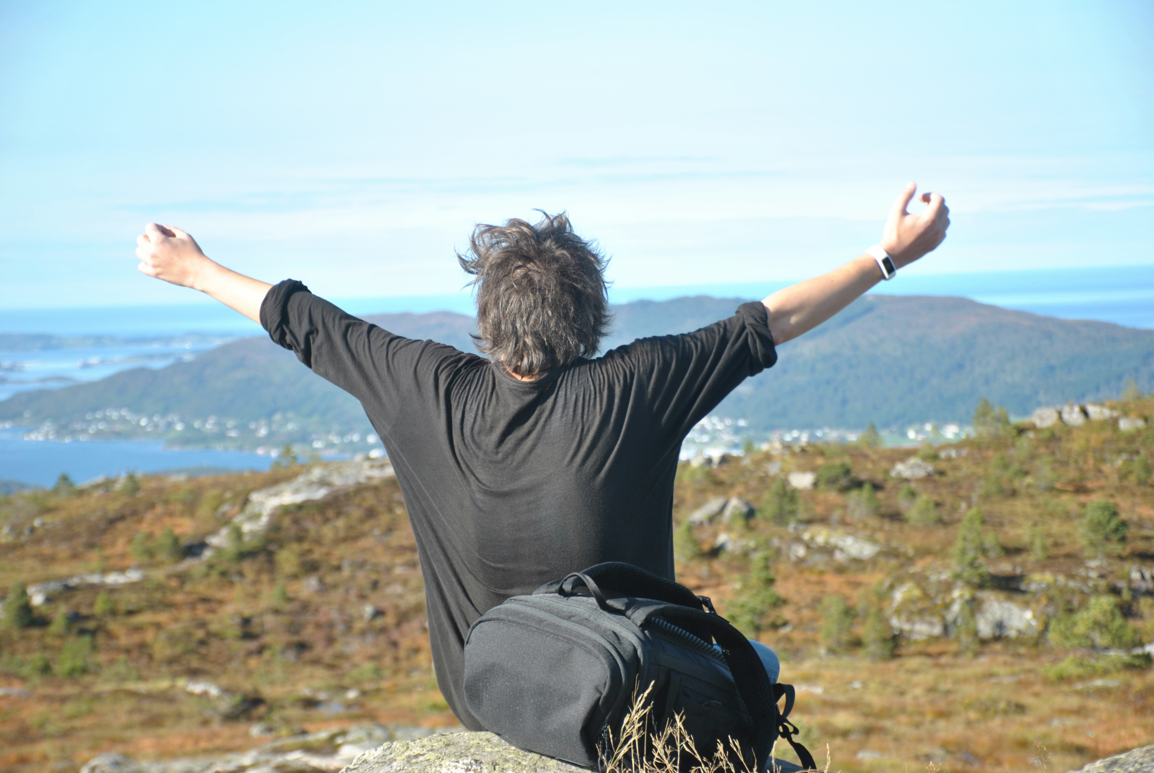 Triumphant View: A Backpacker Embracing the Horizon