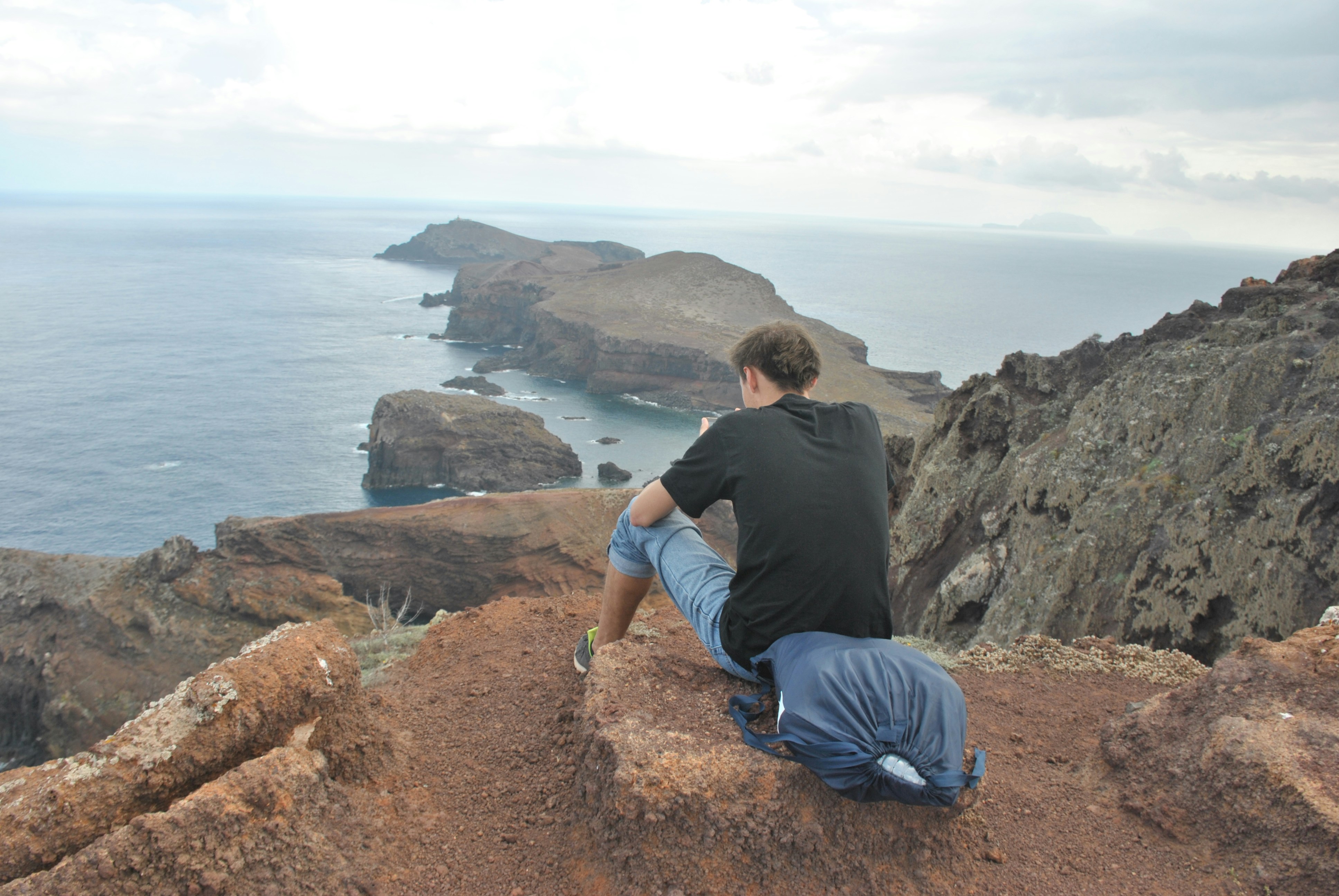 Seated Seacliff Echo: A lone climber surveys the Atlantic Rim