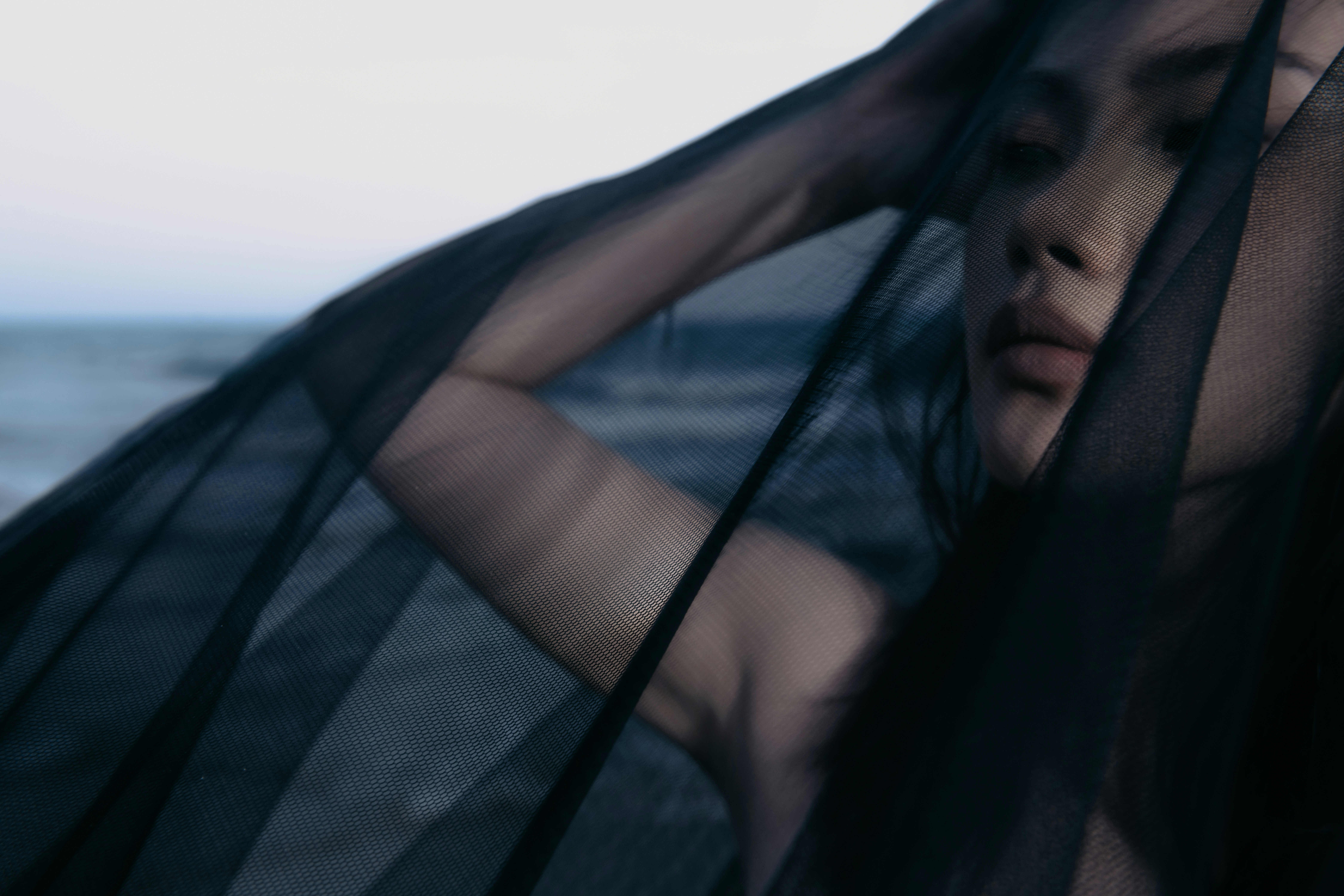 Veiled Gaze at the Edge of Shore
