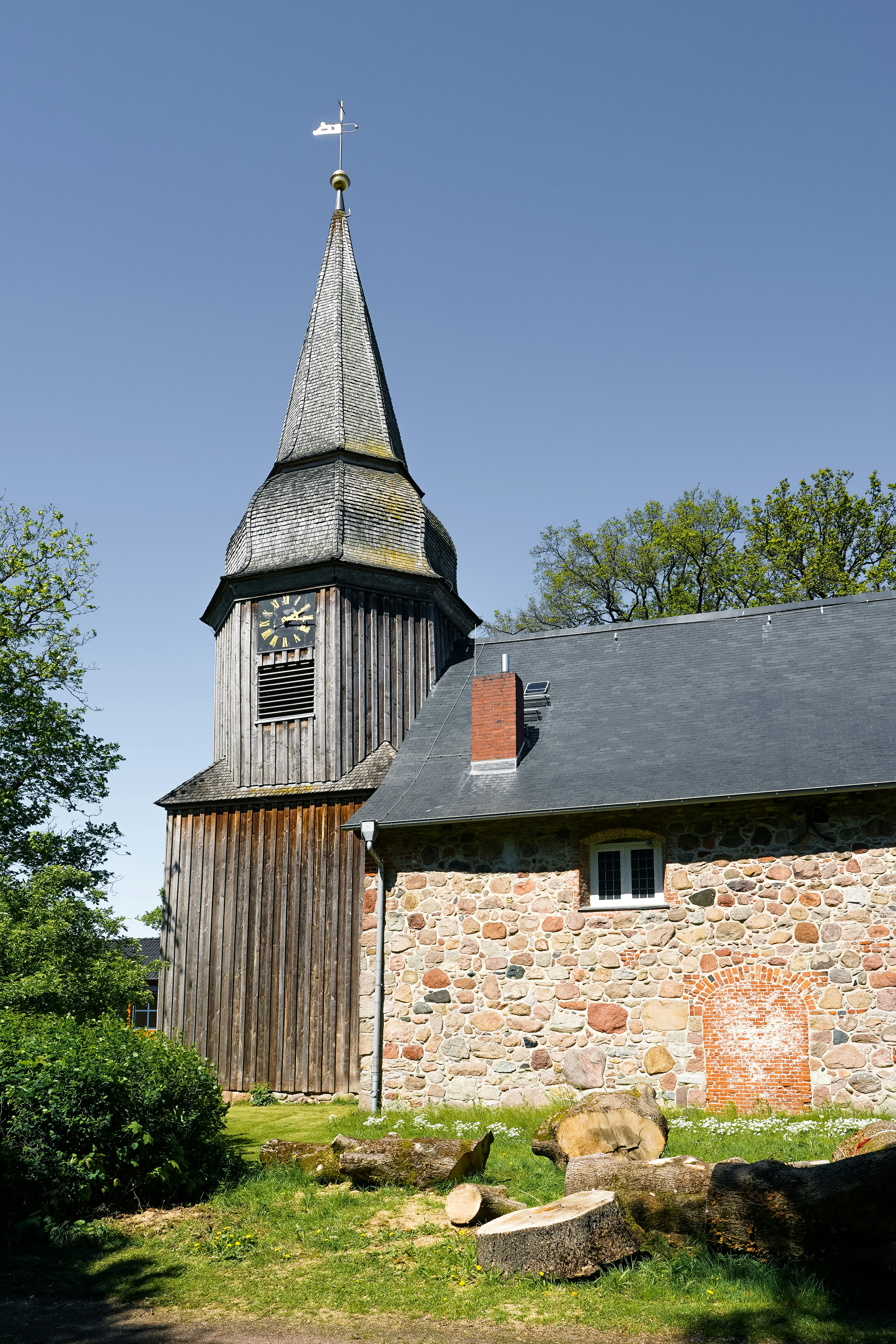 Timber-Studded Bell Tower Rising Beside a Stone Chapel
