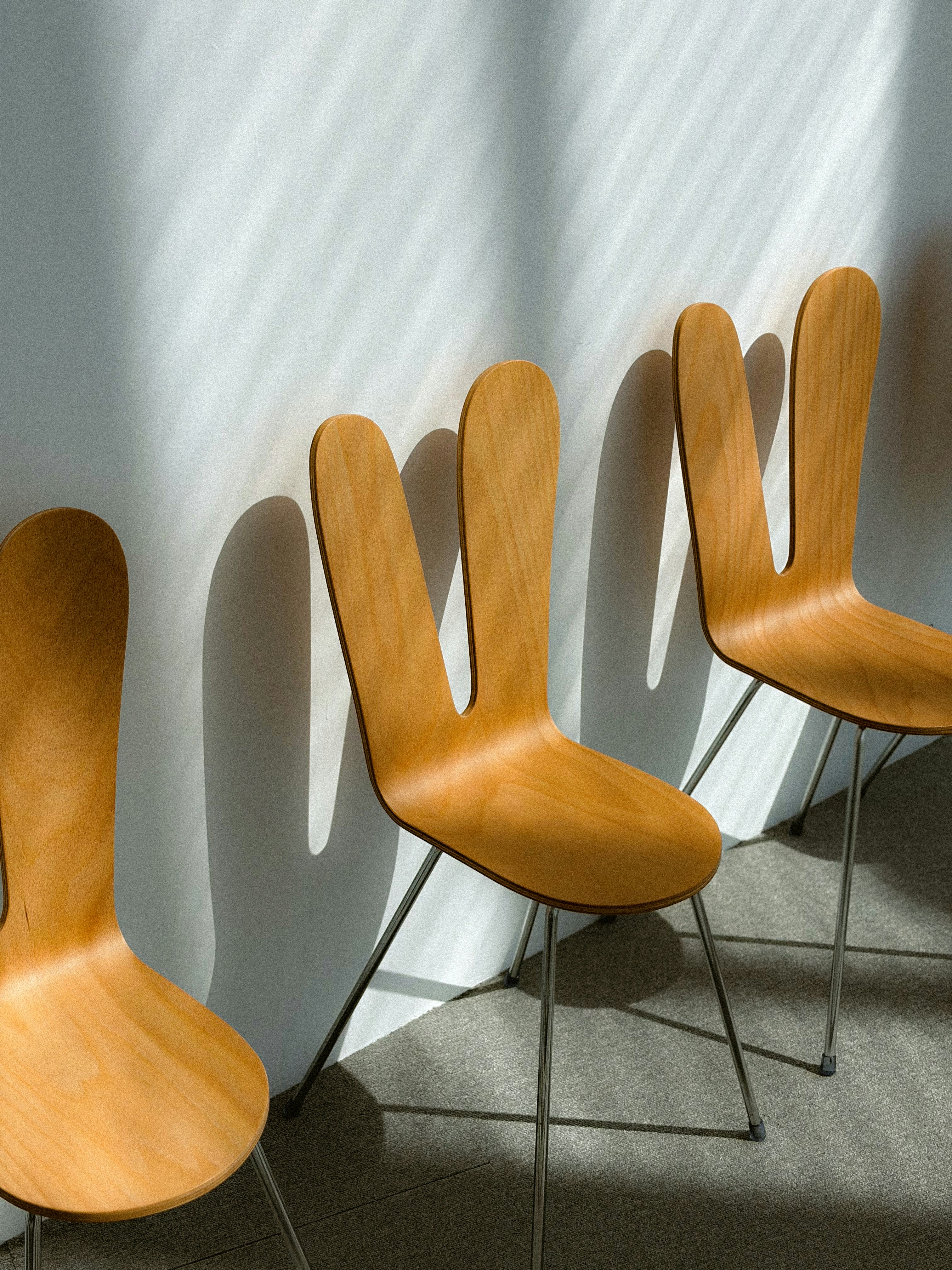 Row of U-Backed Tulip Chairs Casting Long Shadows