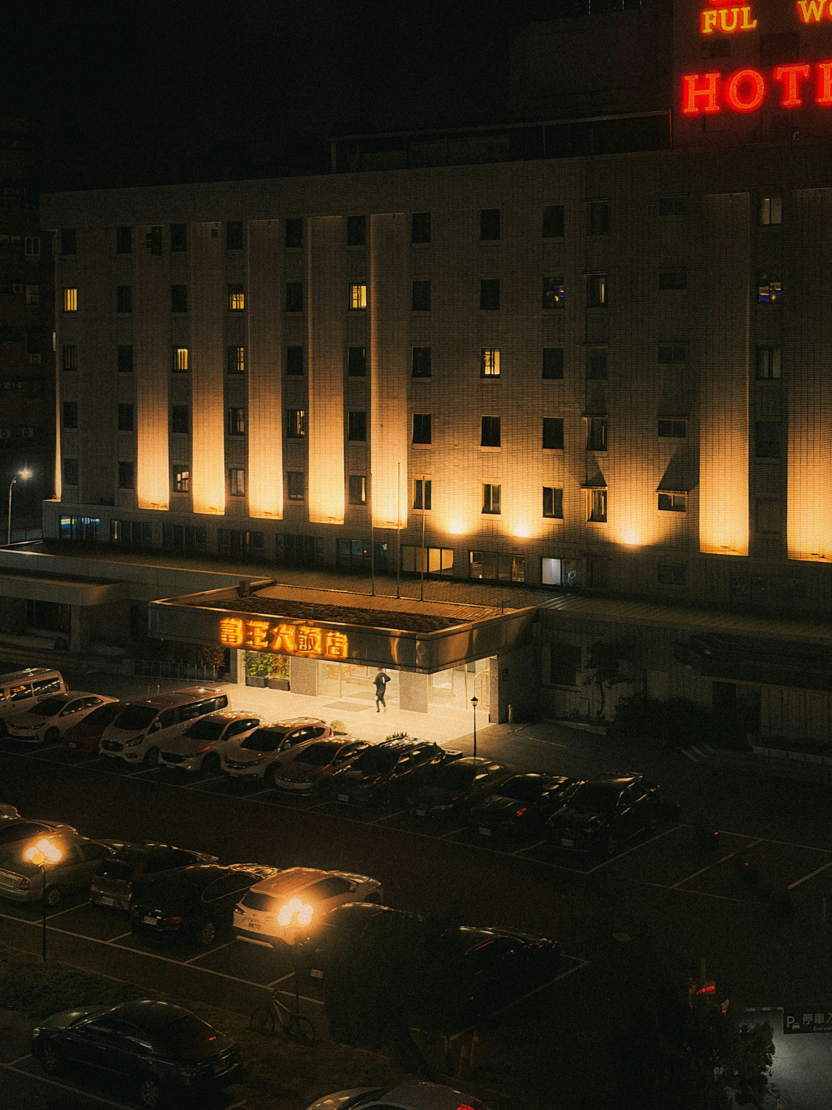 Neon-Fed Facade: Night Spotlight on a Hotel Entrance
