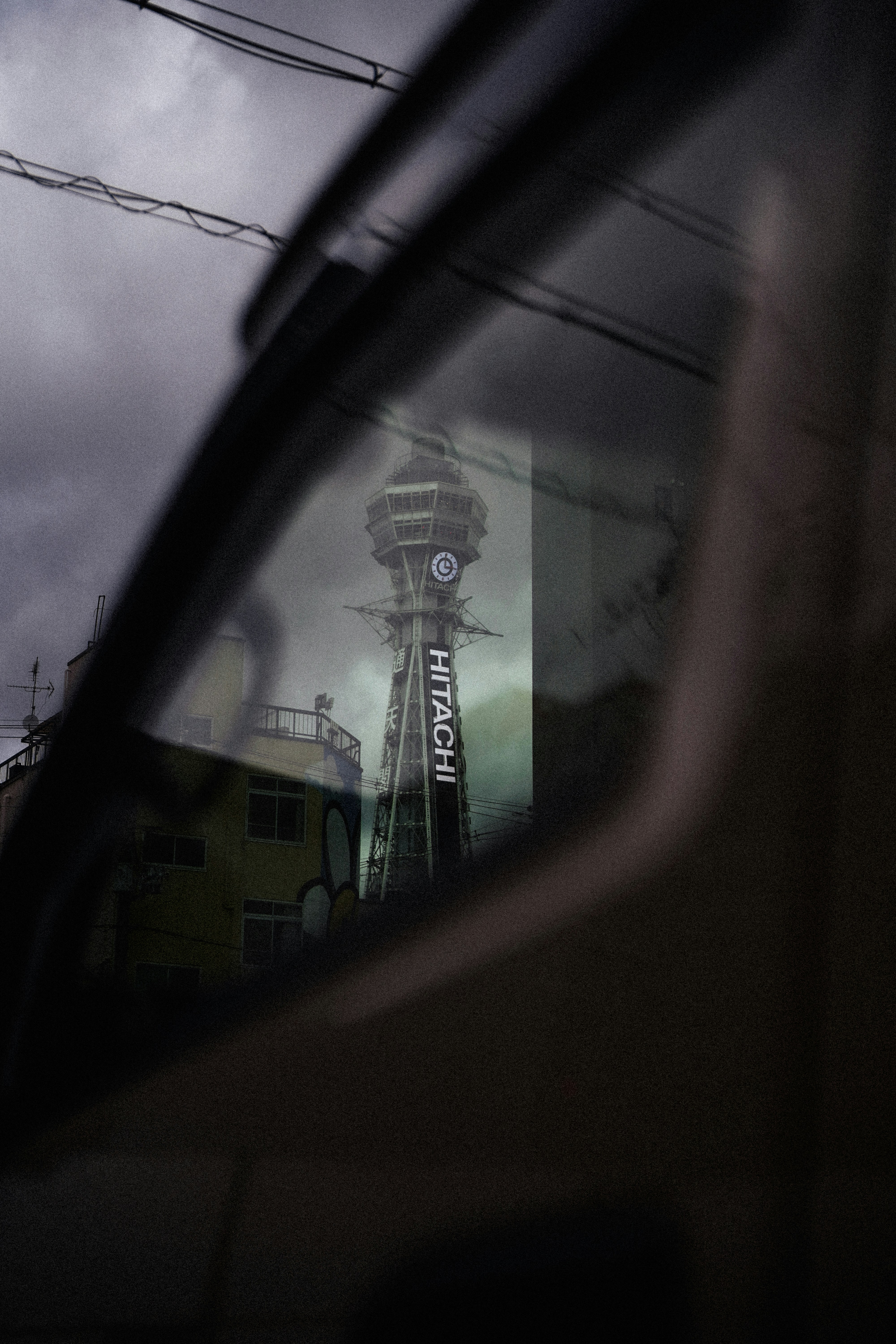 Tower Reflection: City Landmark Pierced by Car Window