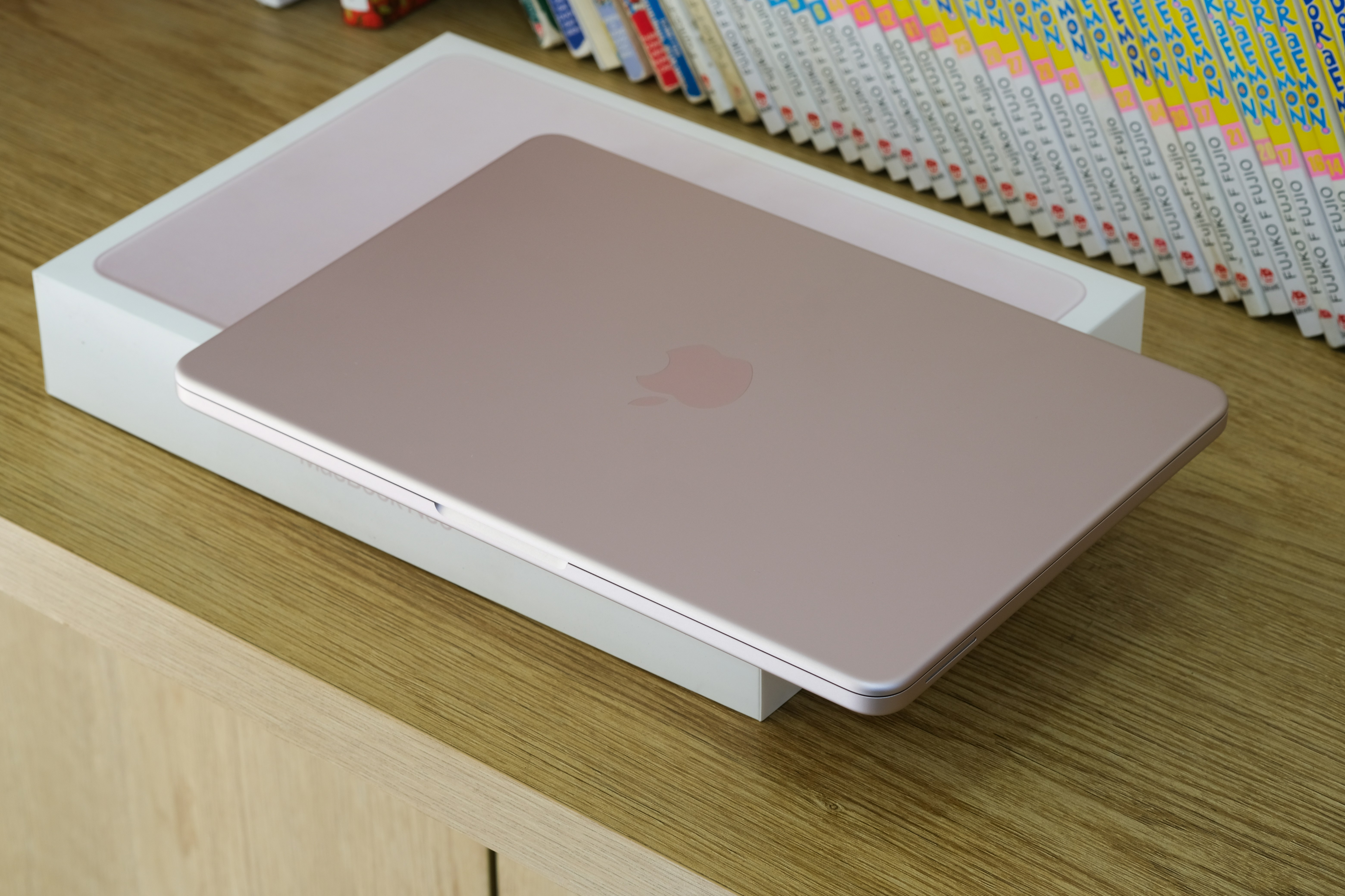 Rosé Pocket: A Rose-Gold iPhone Resting on Its Box