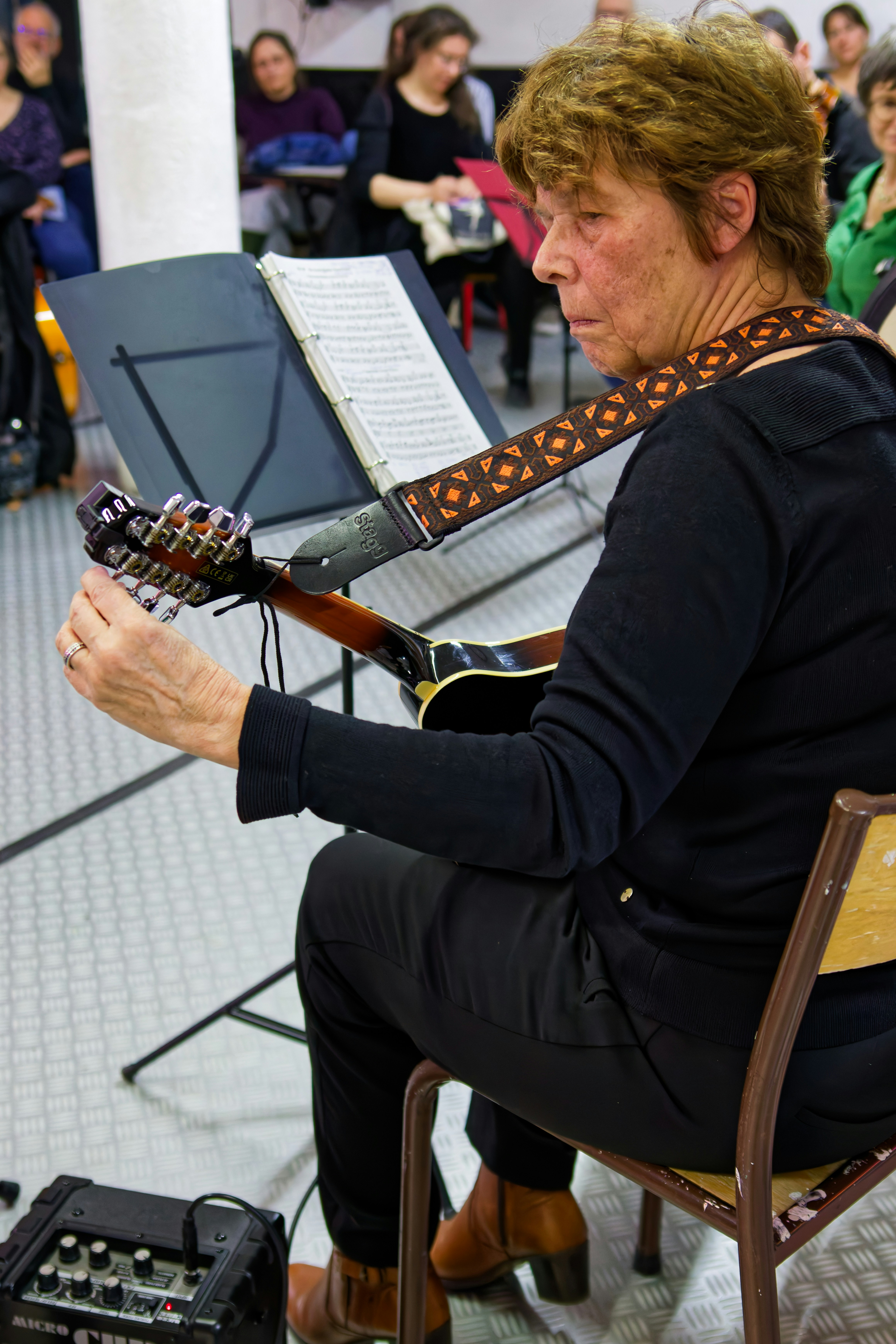 Guitarist in Focus: A Song in a Community Hall