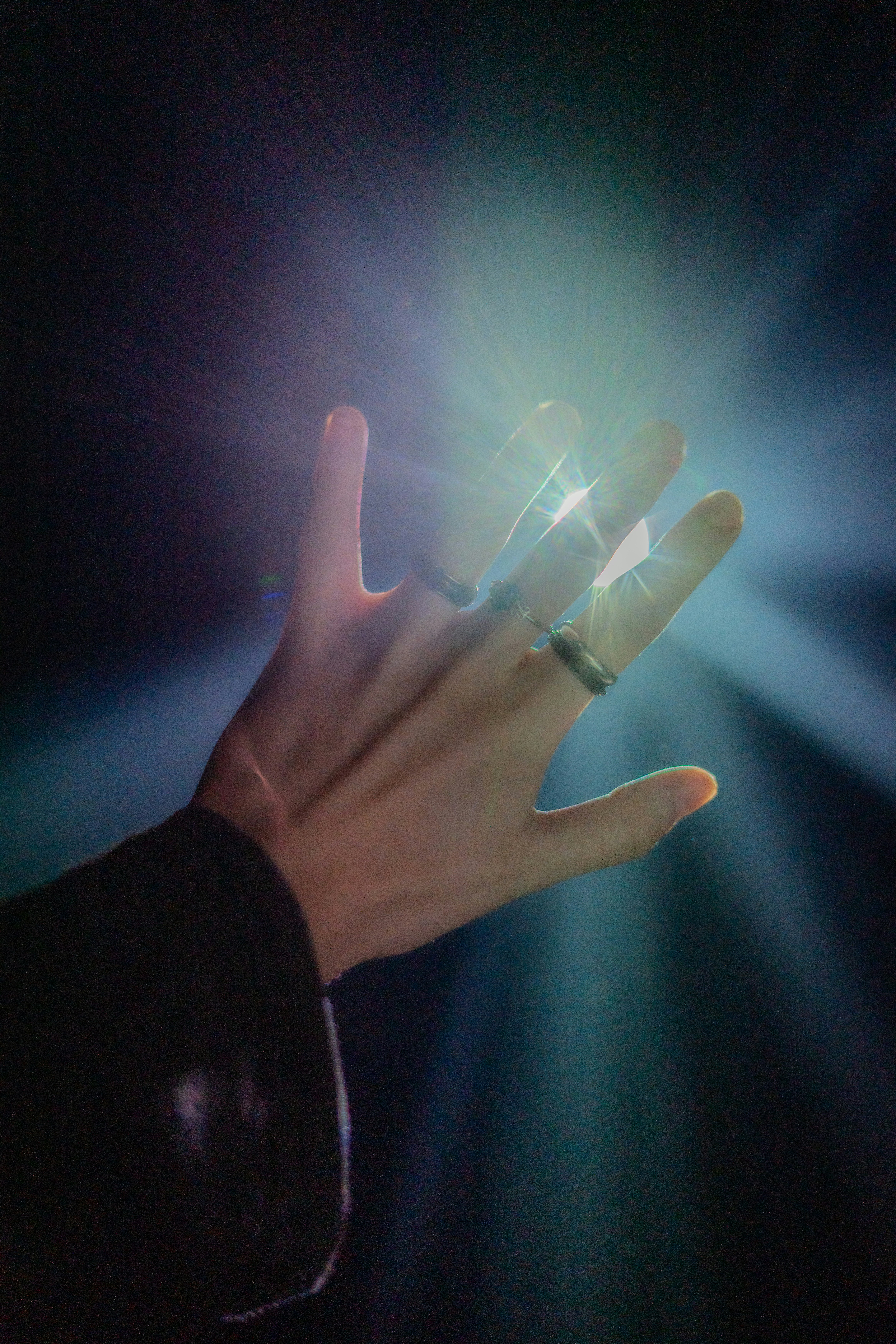 Hand Reaching Toward the Light: A Glimpse Through Nebulous Rays