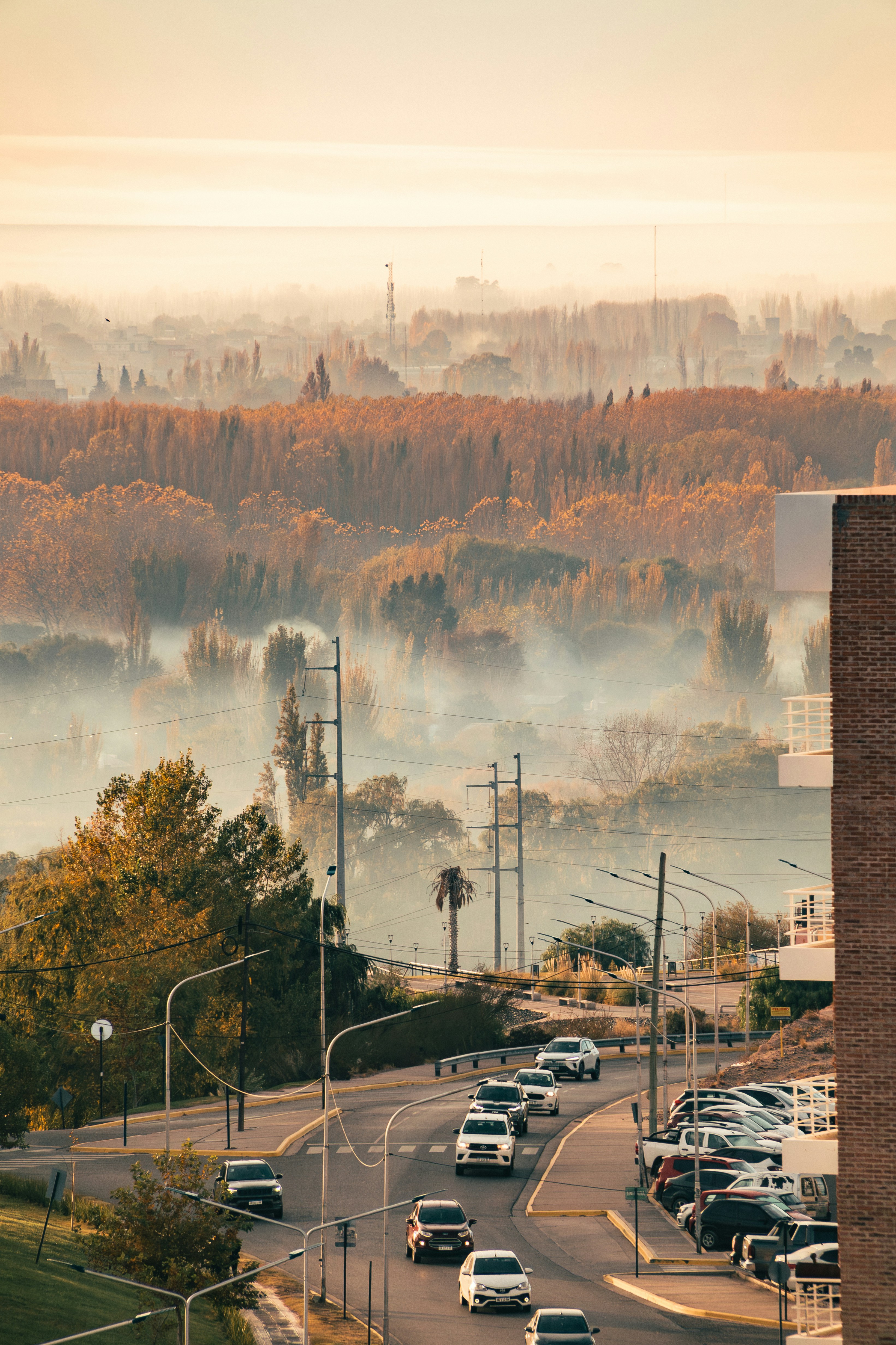 Dawn Descent: Morning Traffic Wums Through a Hazy Suburban Spine