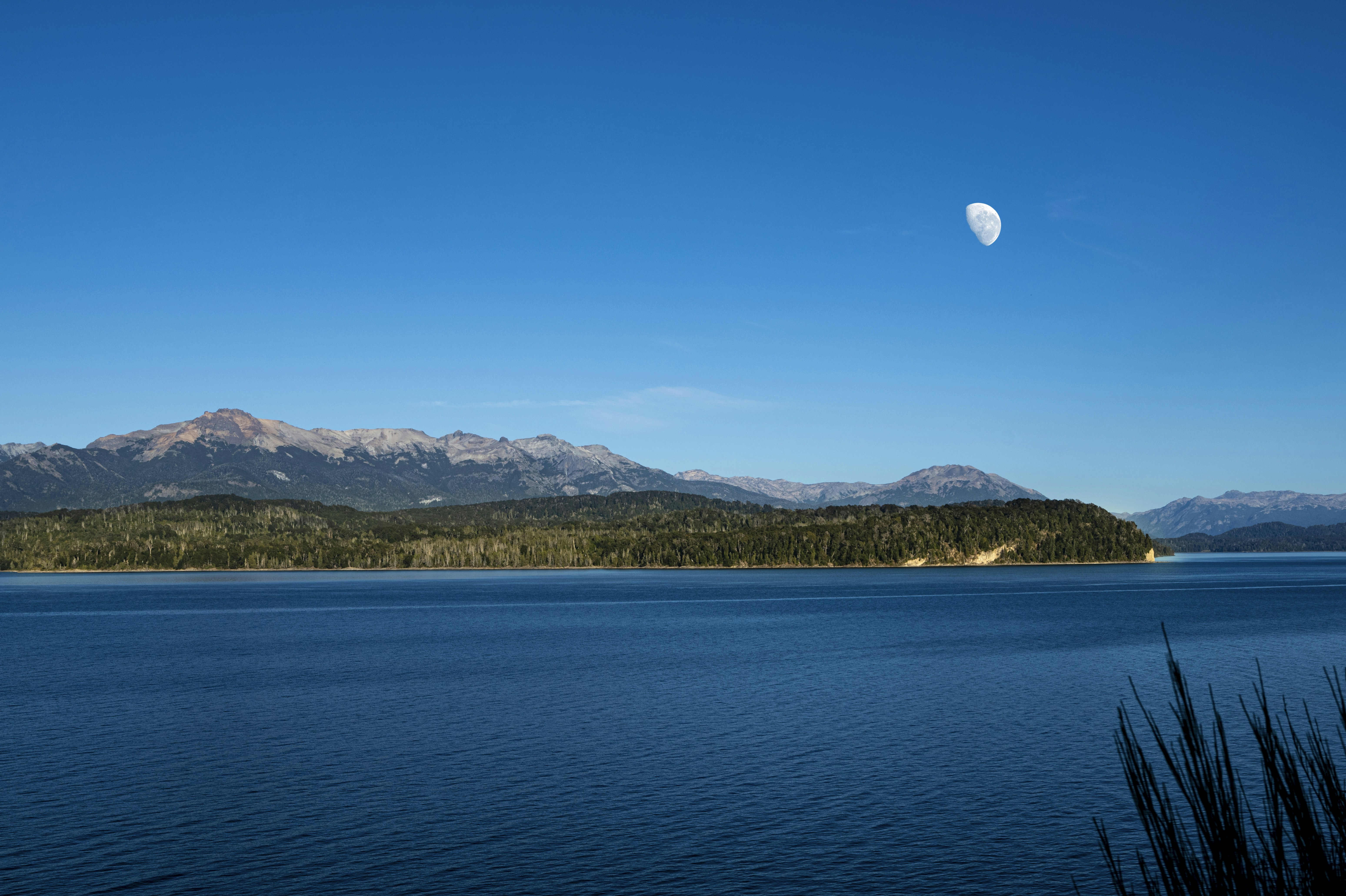 Moon Over Blue Waters: Mountain Rim Beside a Quiet Lake