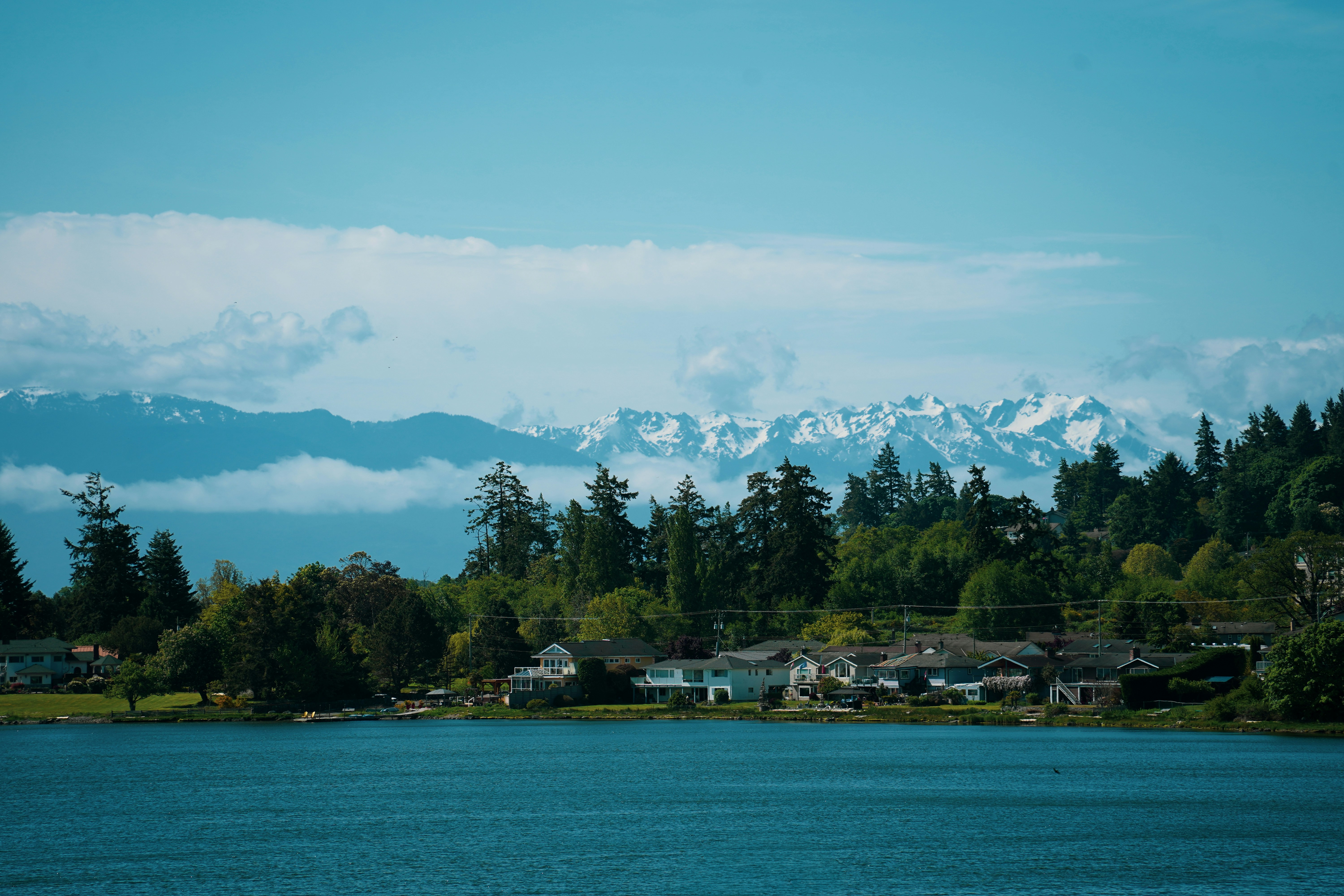 Quiet Waterside Village with Snow-Capped Backdrop