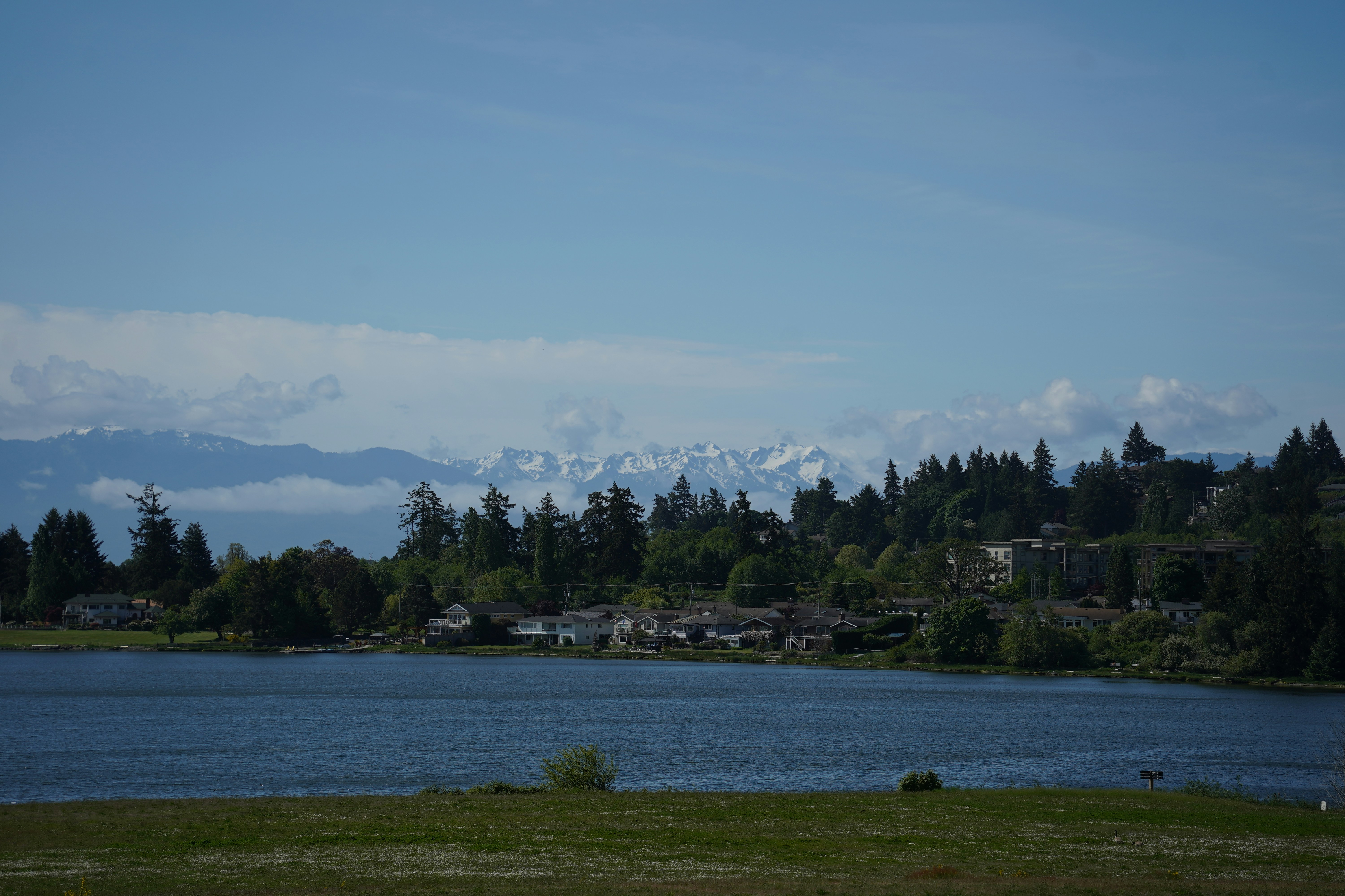 Calm Lakeside Village Framed by Snowcapped Peaks
