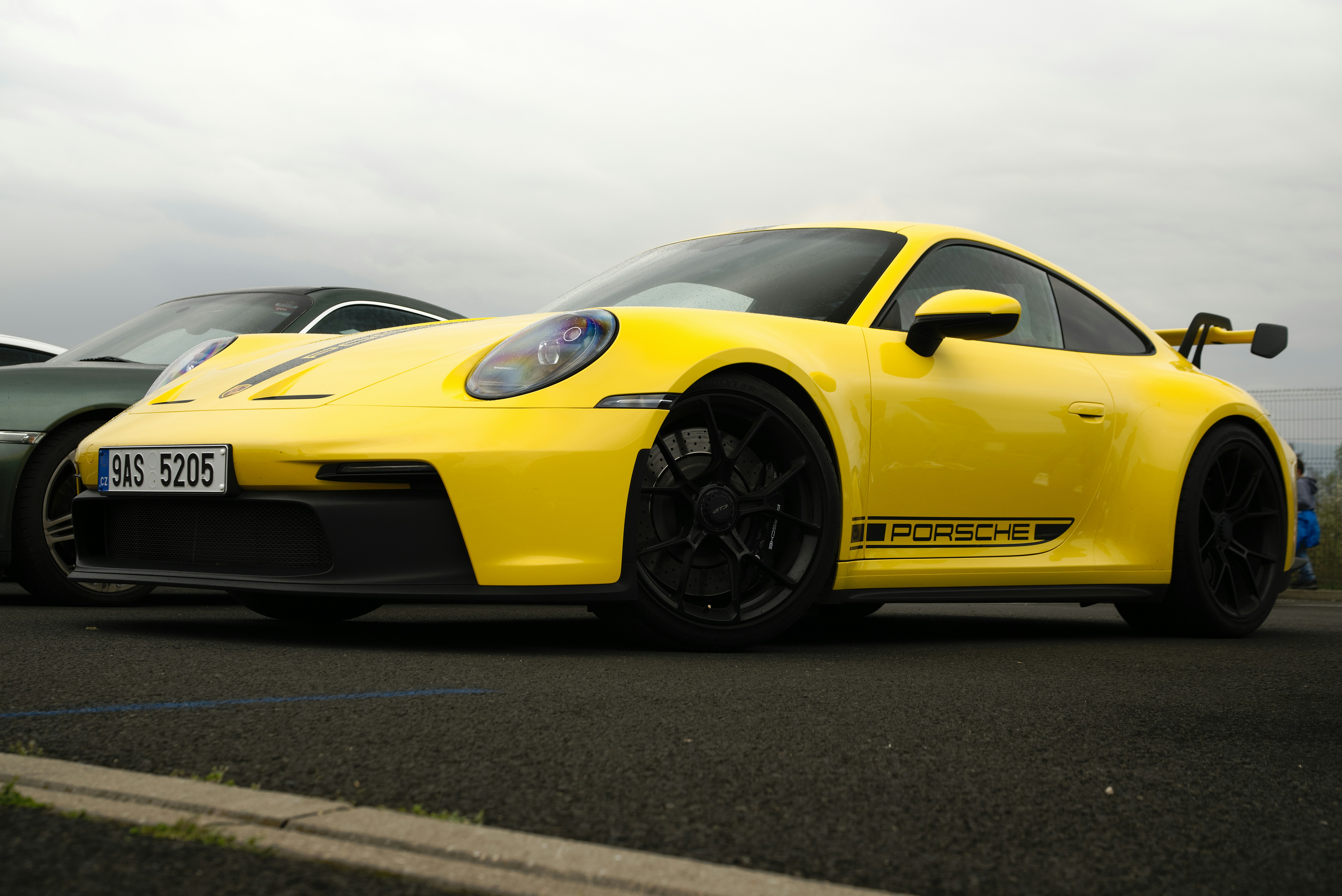 Yellow Porsche GT3 in a Parking Lot: A Low-Angle Stare