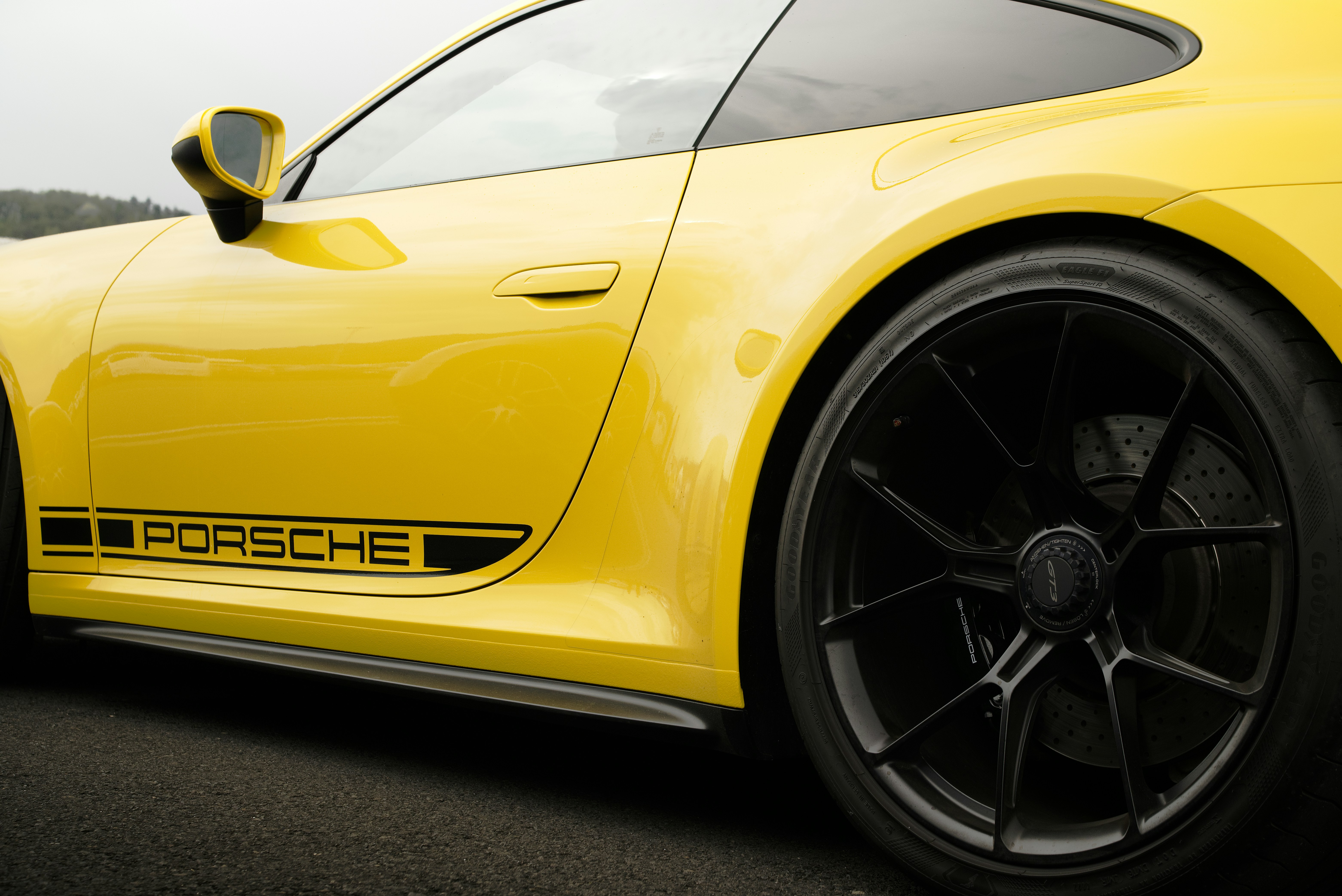 Sleek Yellow Porsche Sidelight and Wheel
