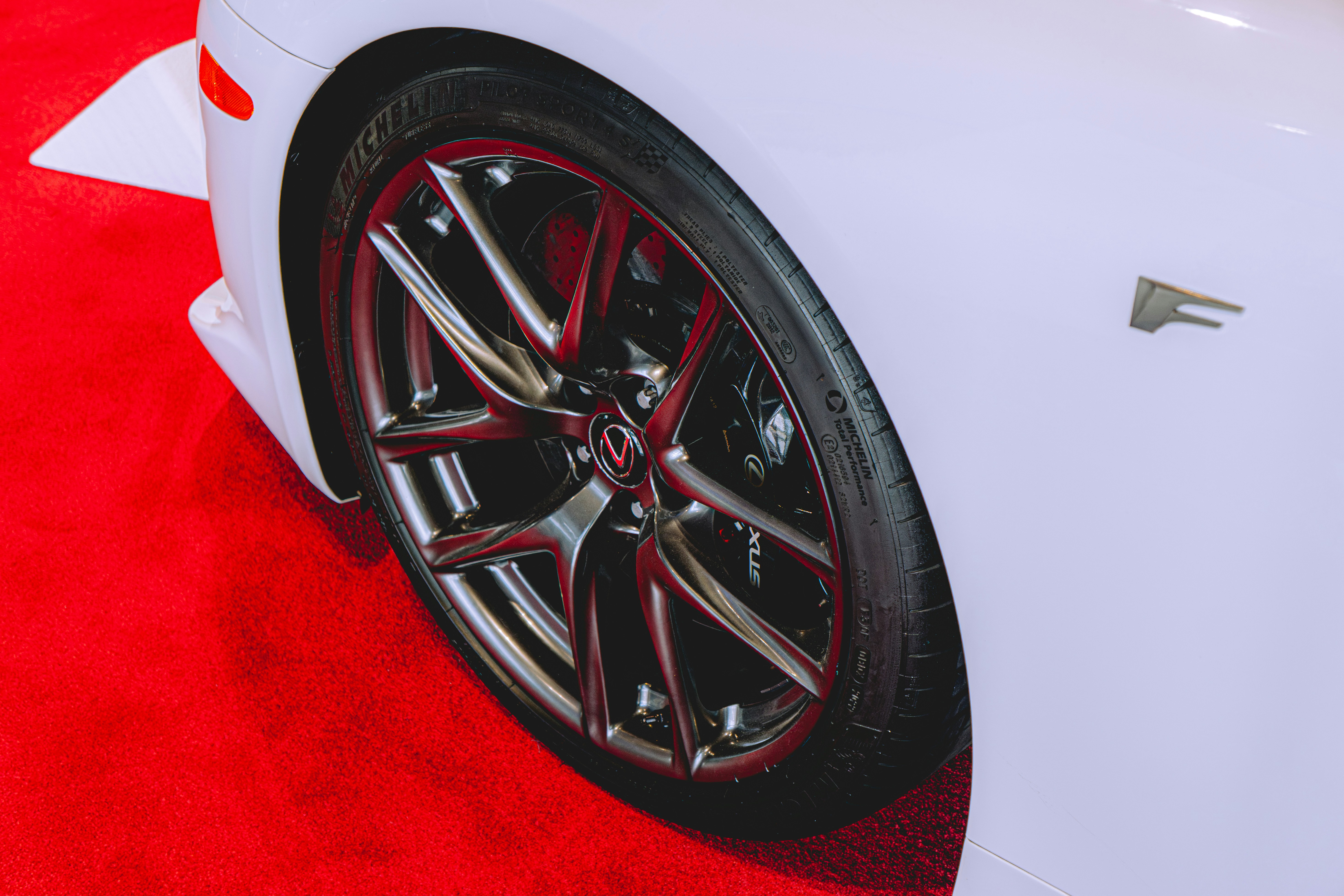 Close-Up of a Glossy Alloy Wheel on a White Sports Car
