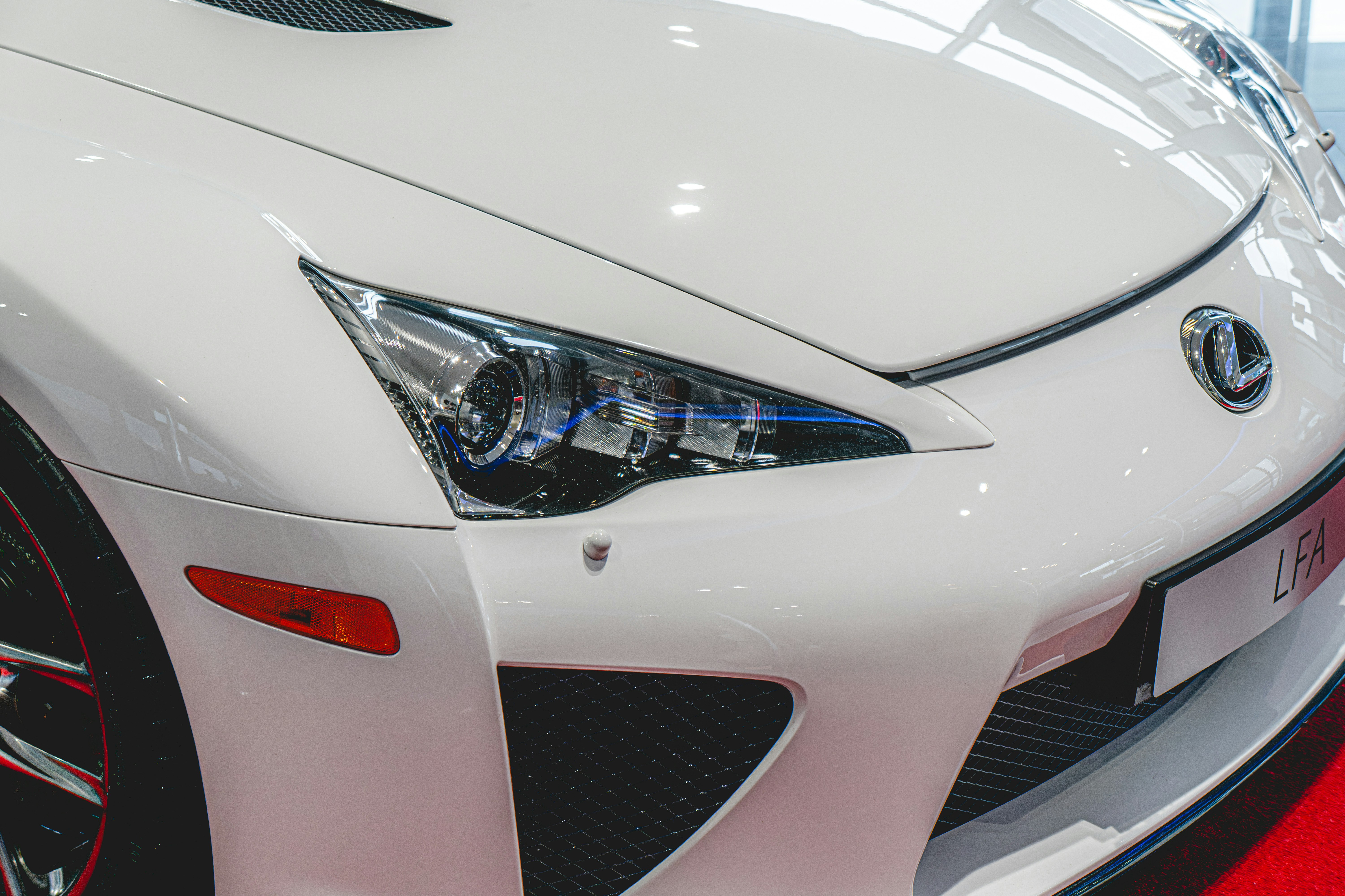 Front-Quarter Elegance: White LFA-Grooved Contours and Sharp Headlamp Lines