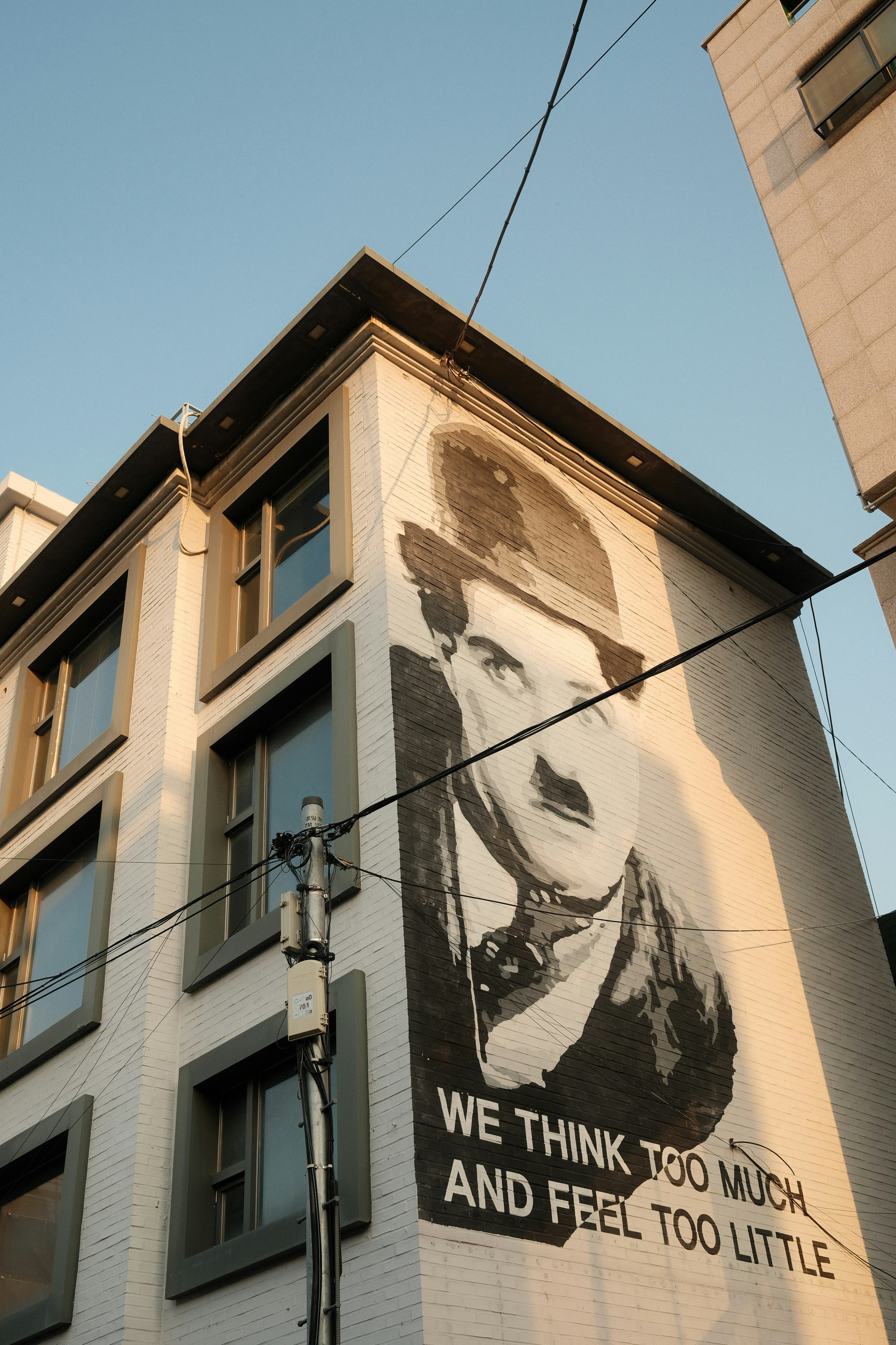 Portrait on Brick: A Static Figure Reaching Skyward on a Painted Wall