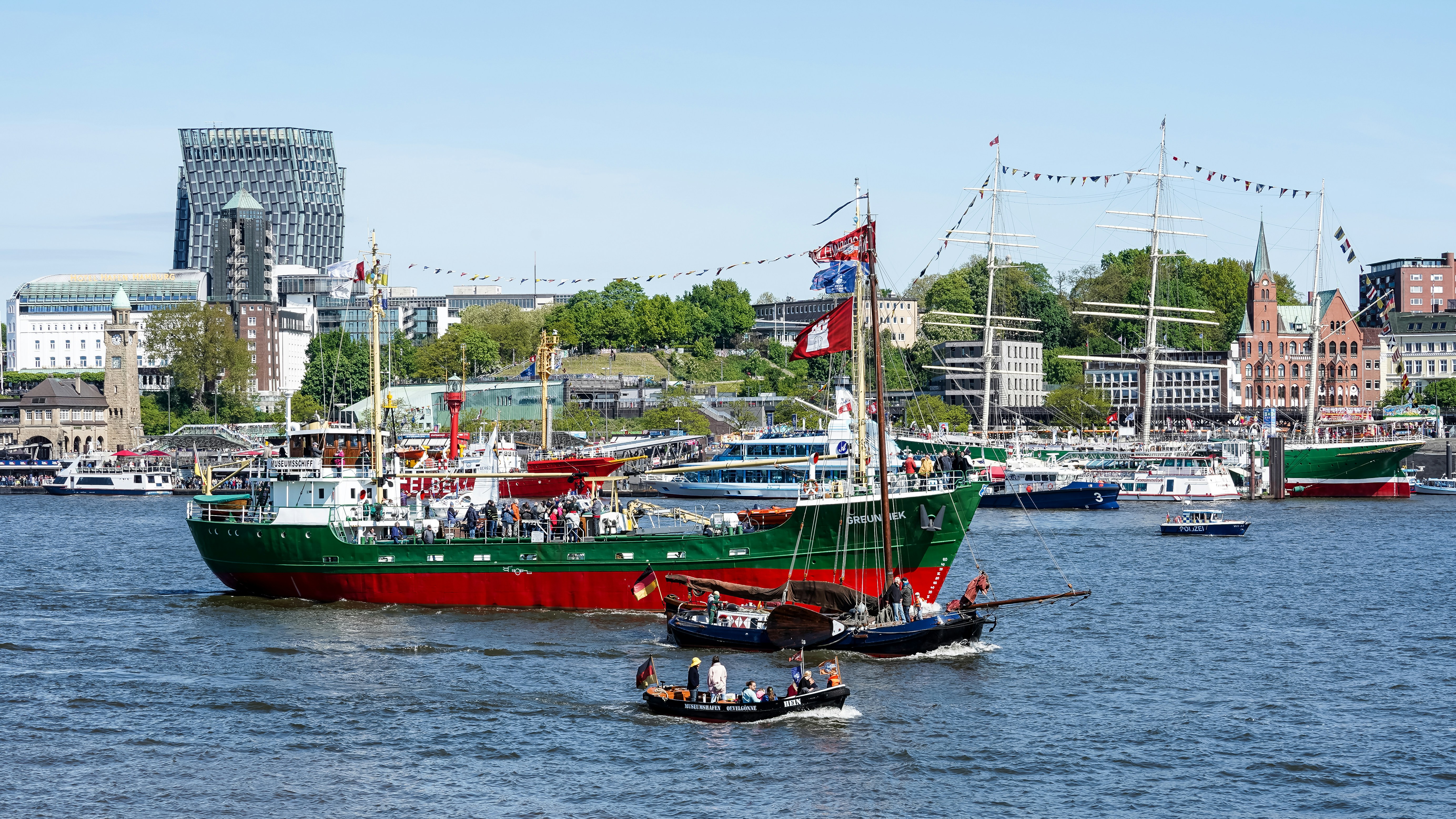 Harbor Parade: A Fleet of Colorful Vessels on a Calm River