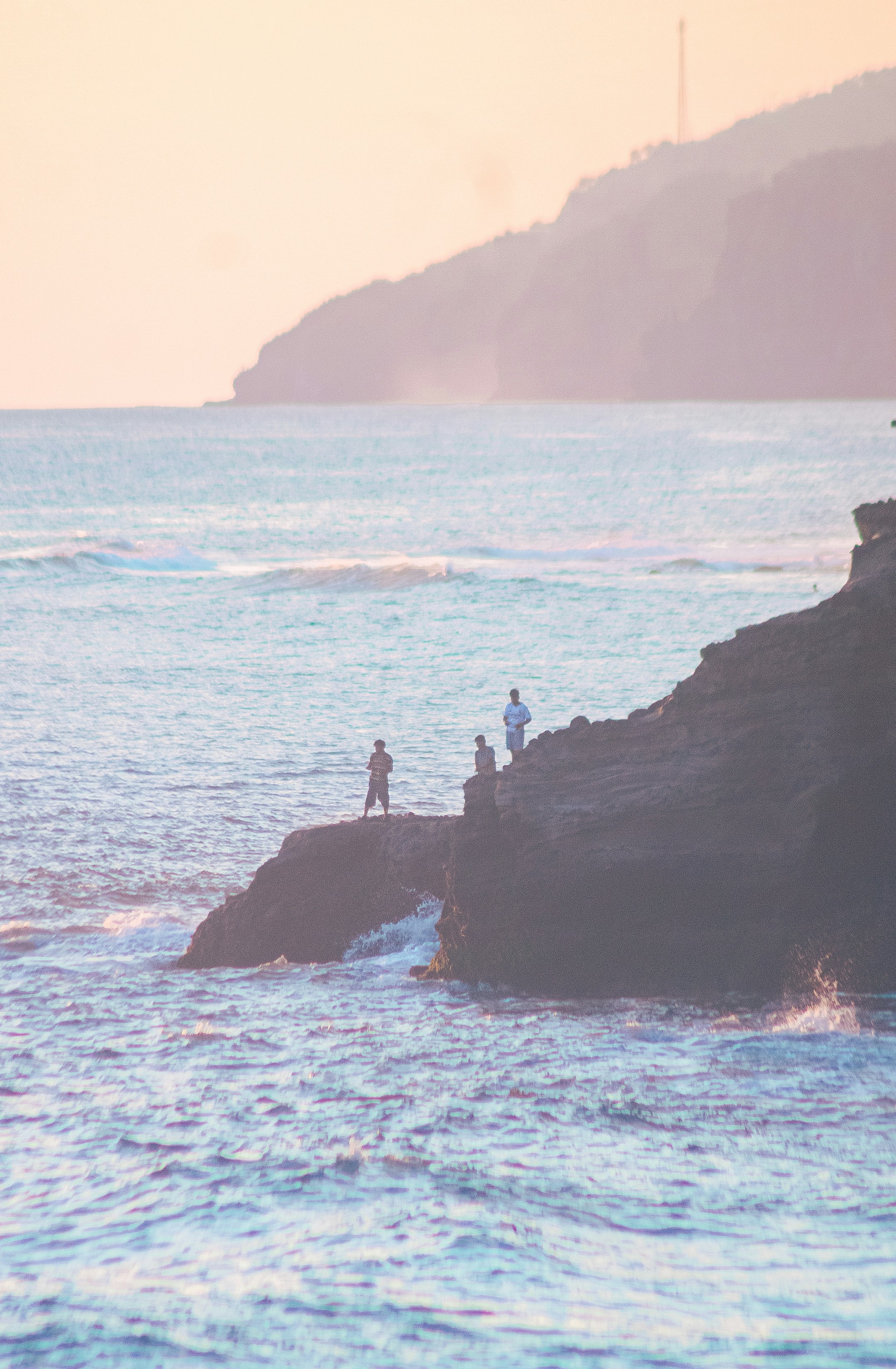 Lighthouse Silhouette: Figures on a Cretan Cliff at Dusk