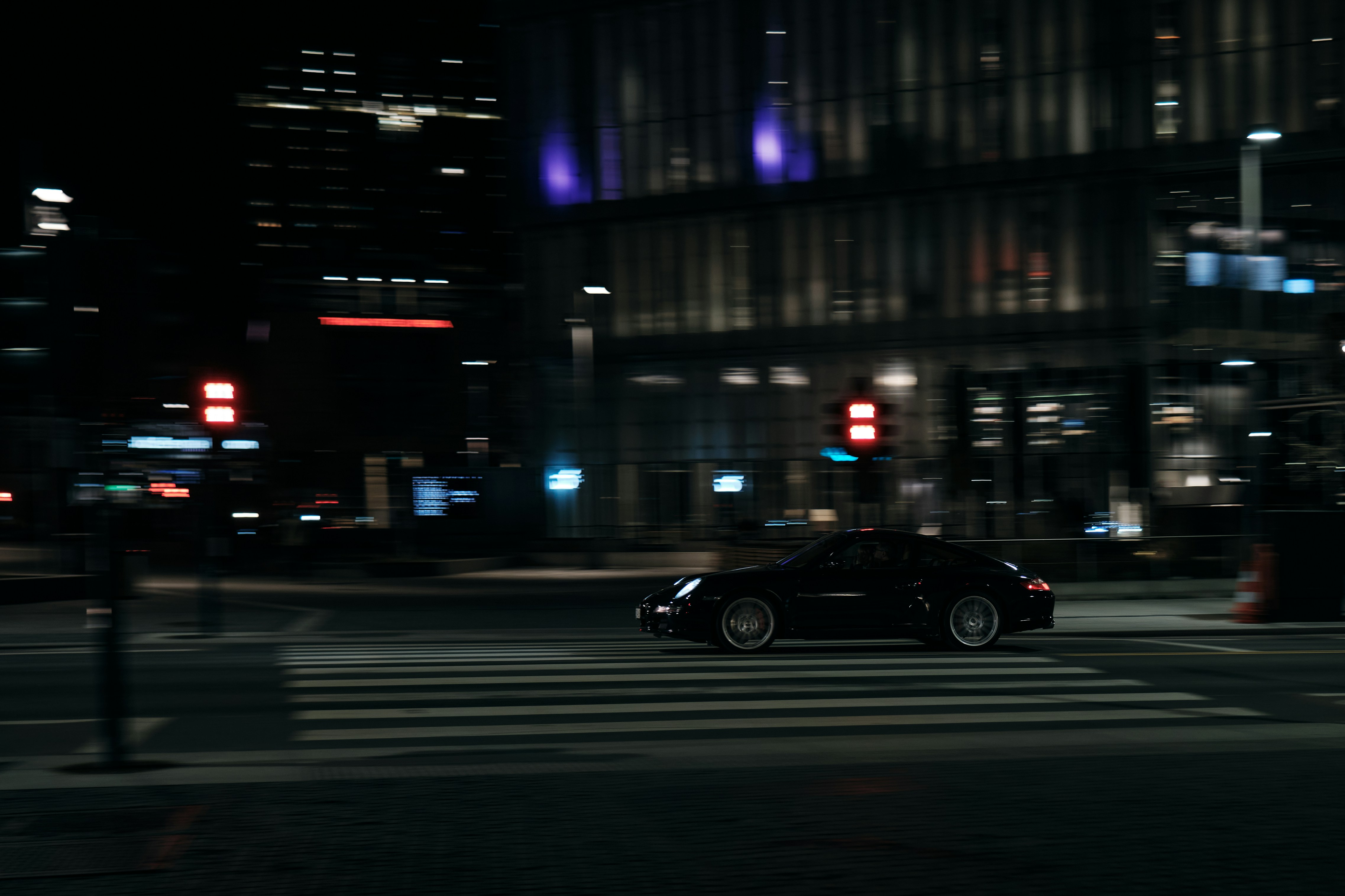 Midnight City Drift: A Black Sports Car Strides Through Neon Quiet