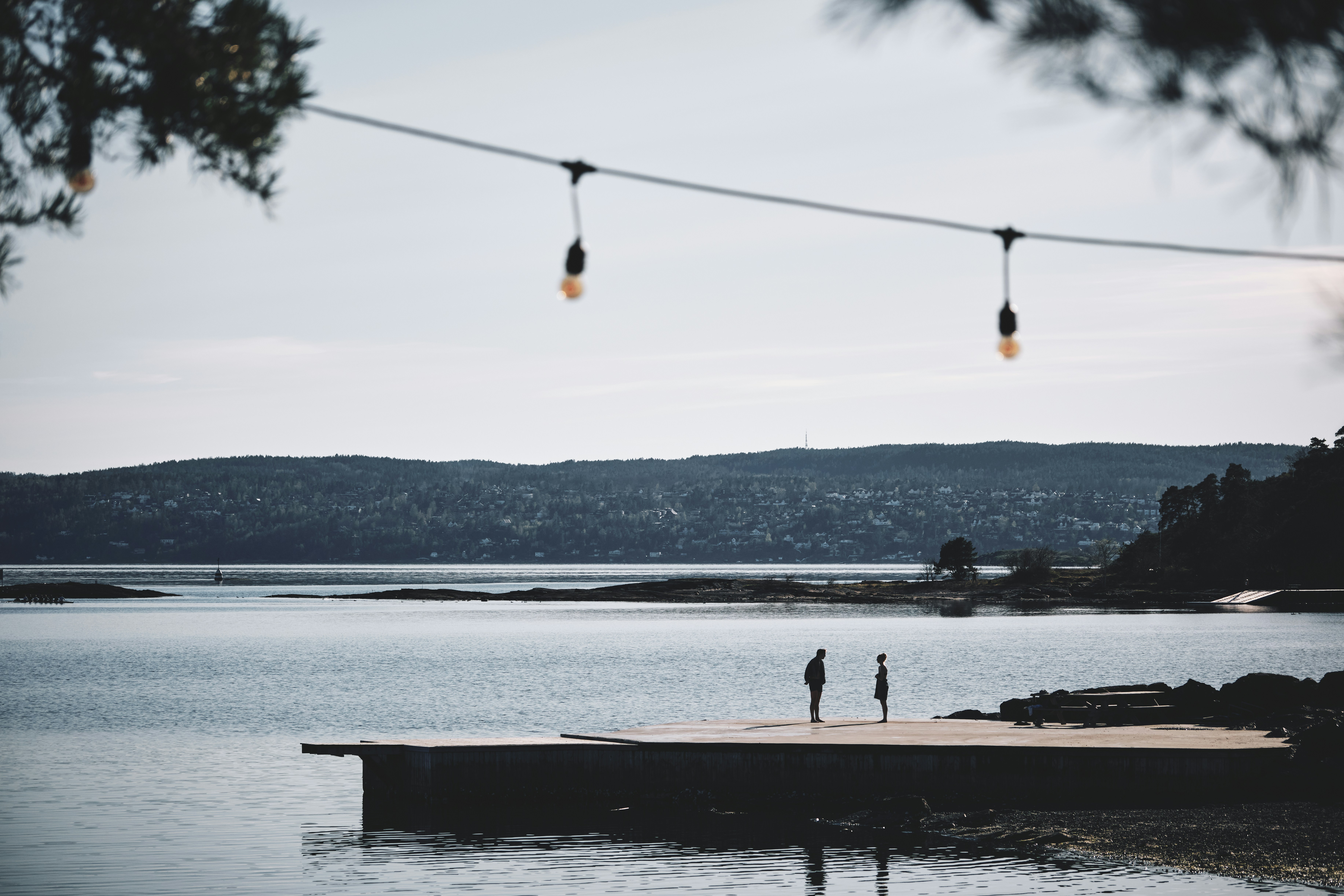 Distant Figures at Dusk Over a Calm Peninsula