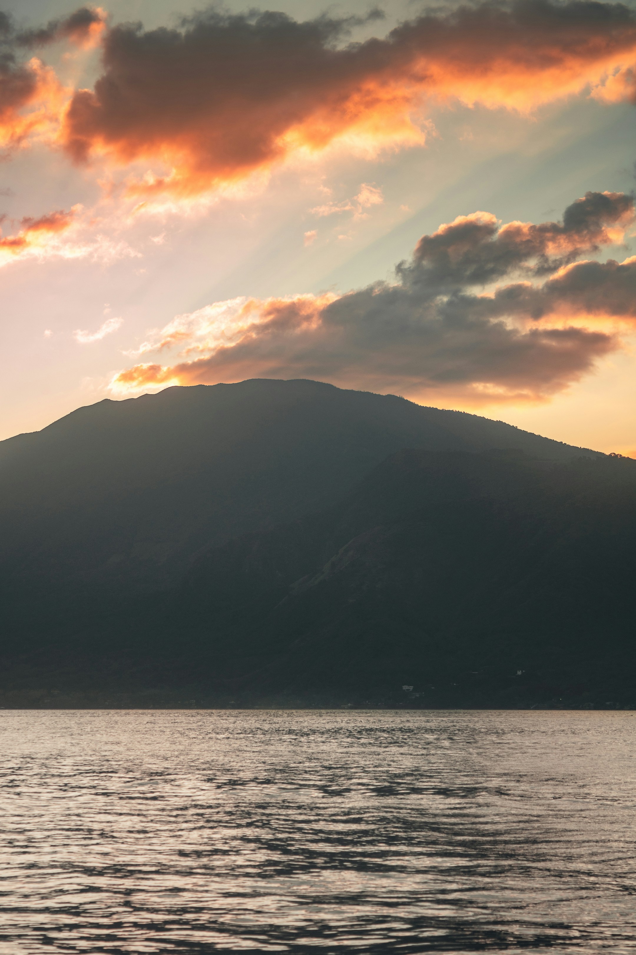 Dusk Over the Fjord: Mountain silhouette and shimmering sea
