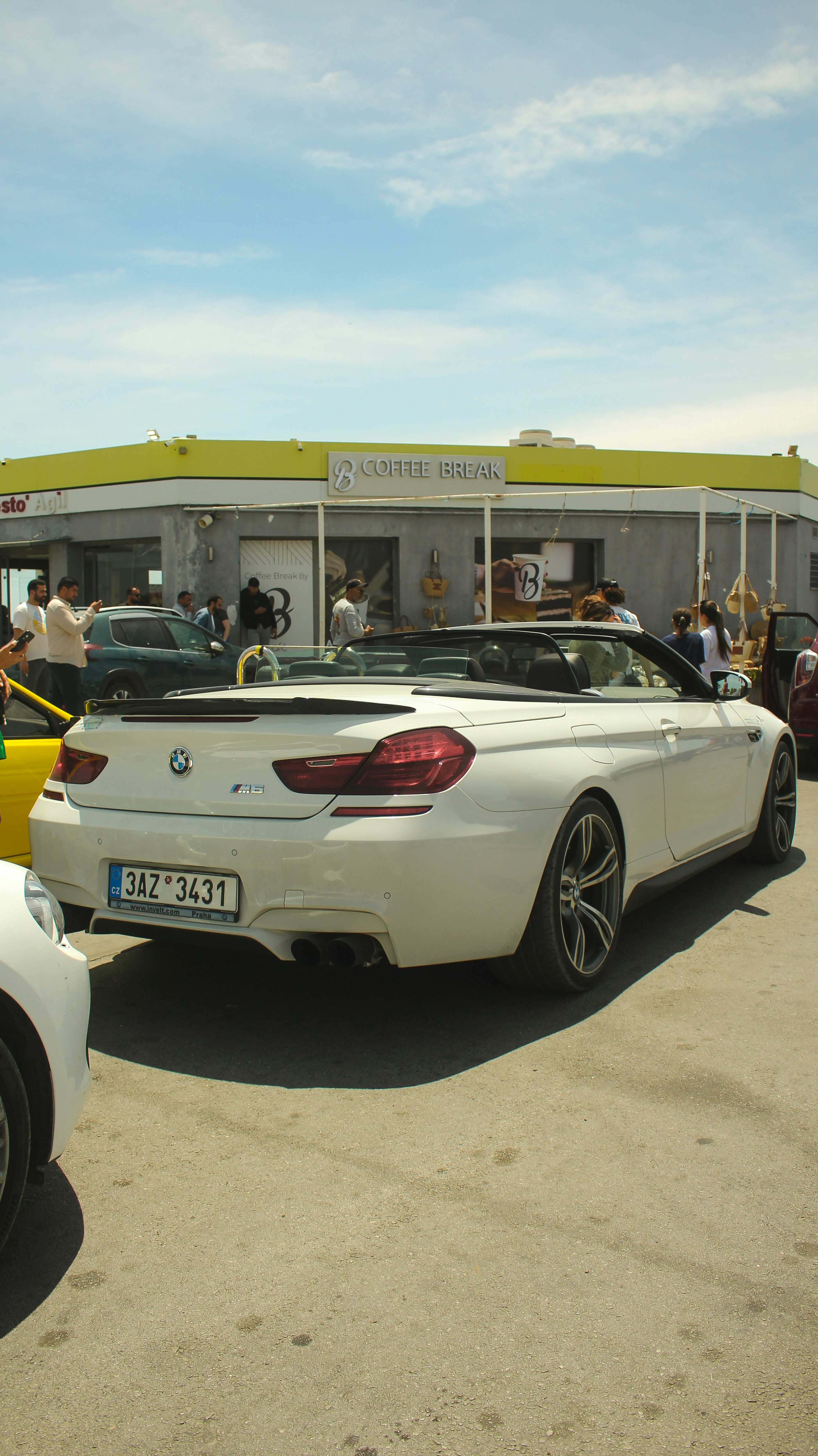White BMW Roadster at a Sunlit Café Rally