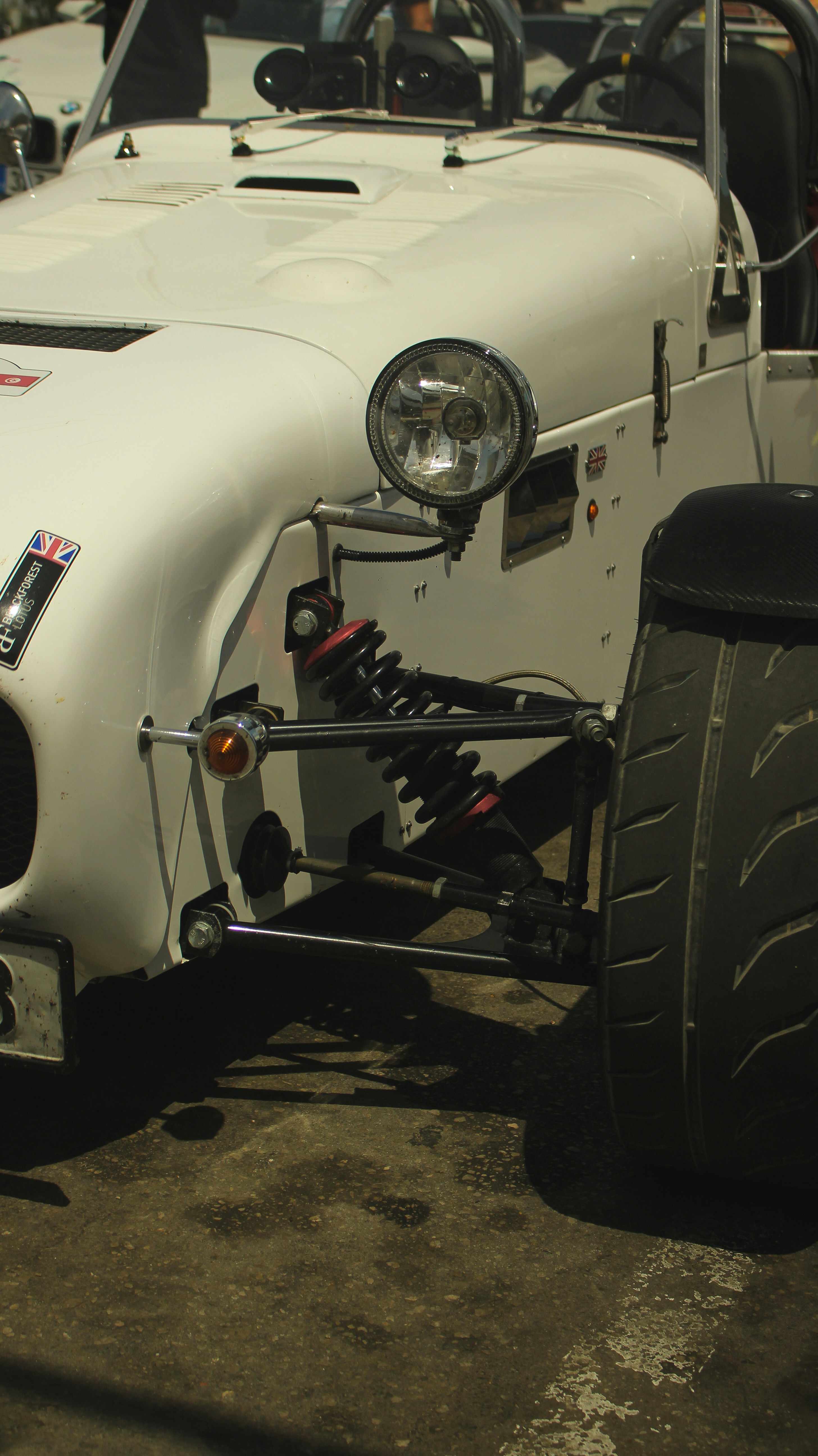 White vintage racer: front wheel, headlamp and suspension detail