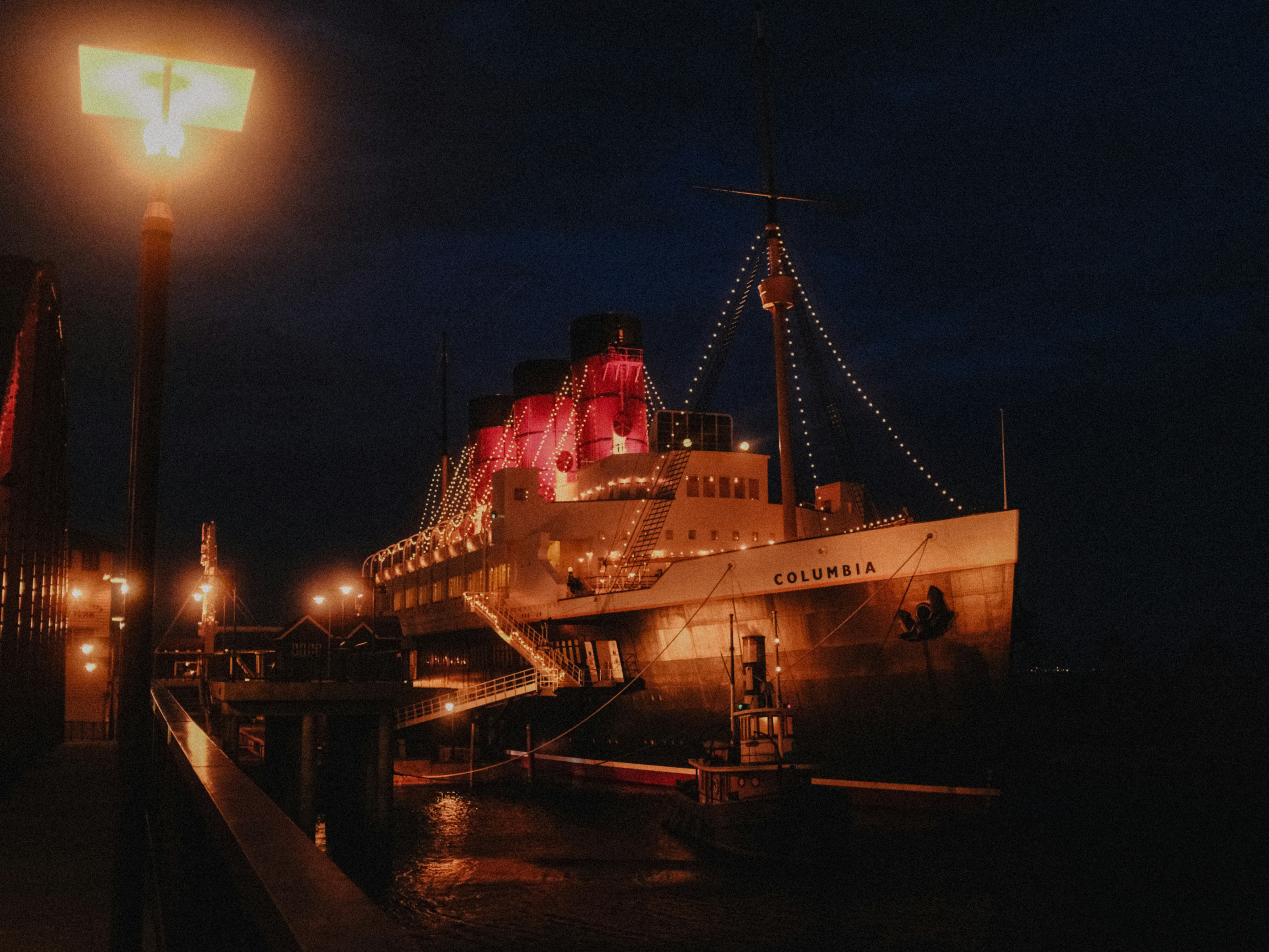 Moonlit Vessel: A Historic Ship Lined with Warm Dusk Lights