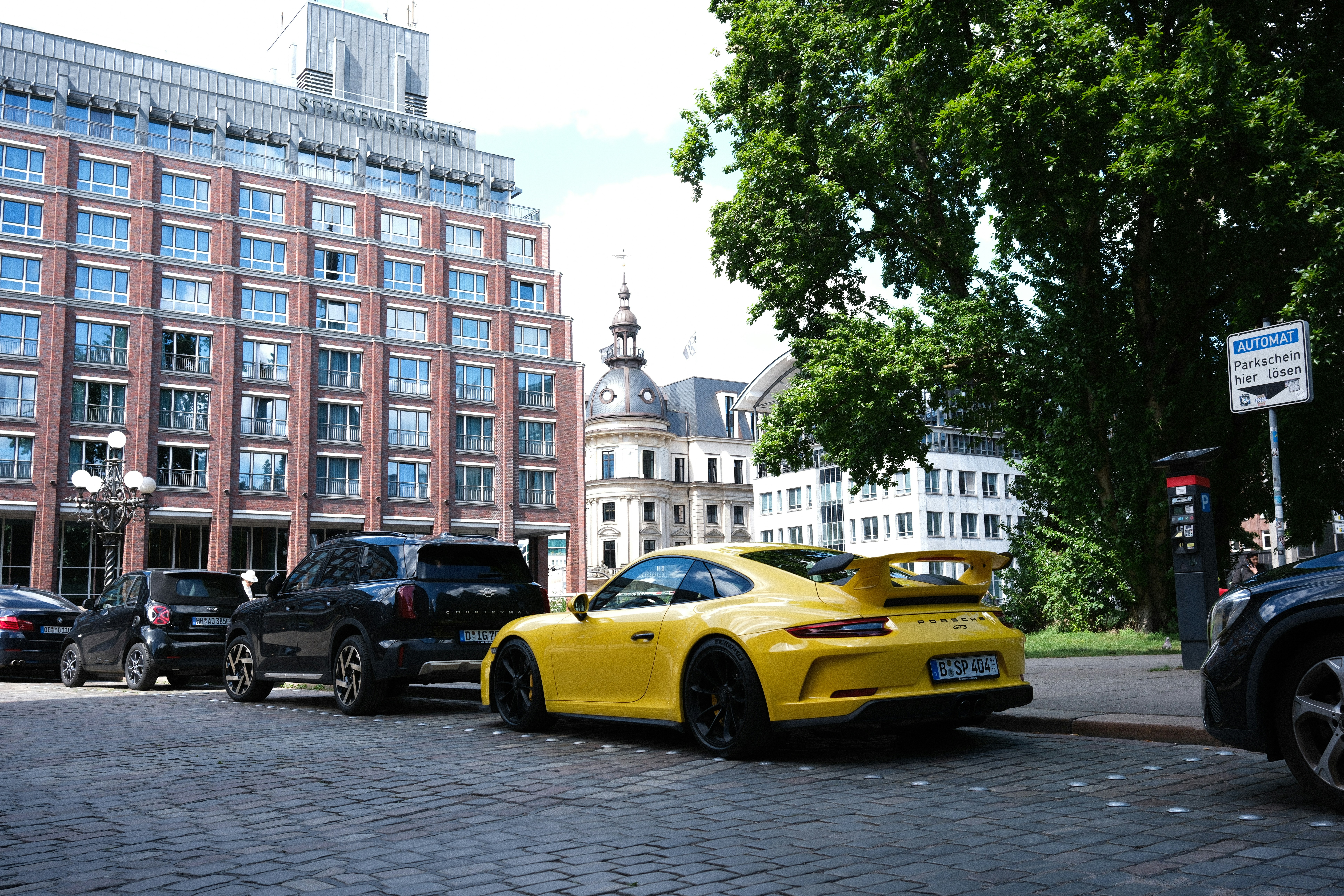Yellow sports car anchor amid urban cobblestones