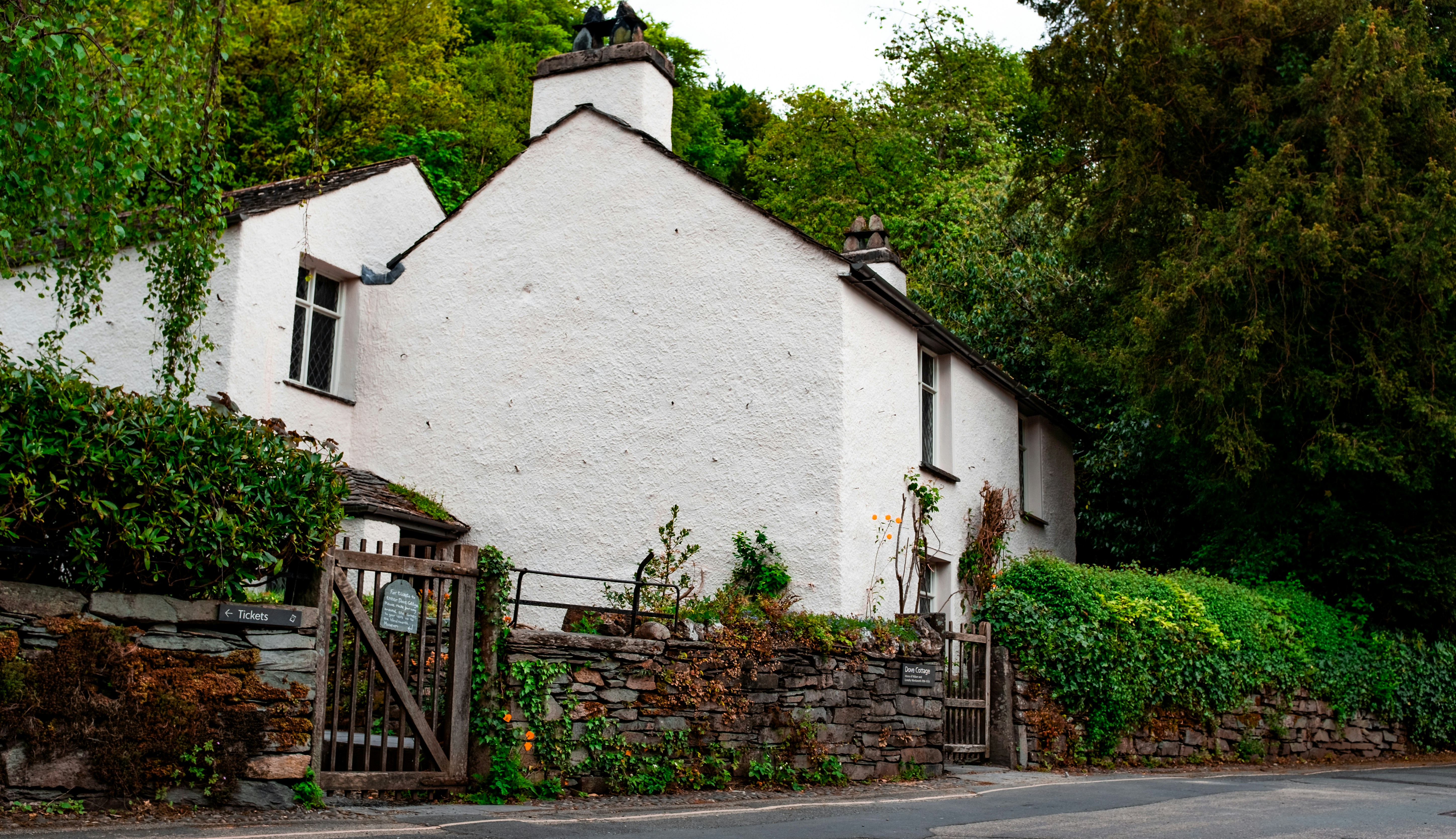 White Cottage on a Stone Terrace Quietly Framed by Greenery