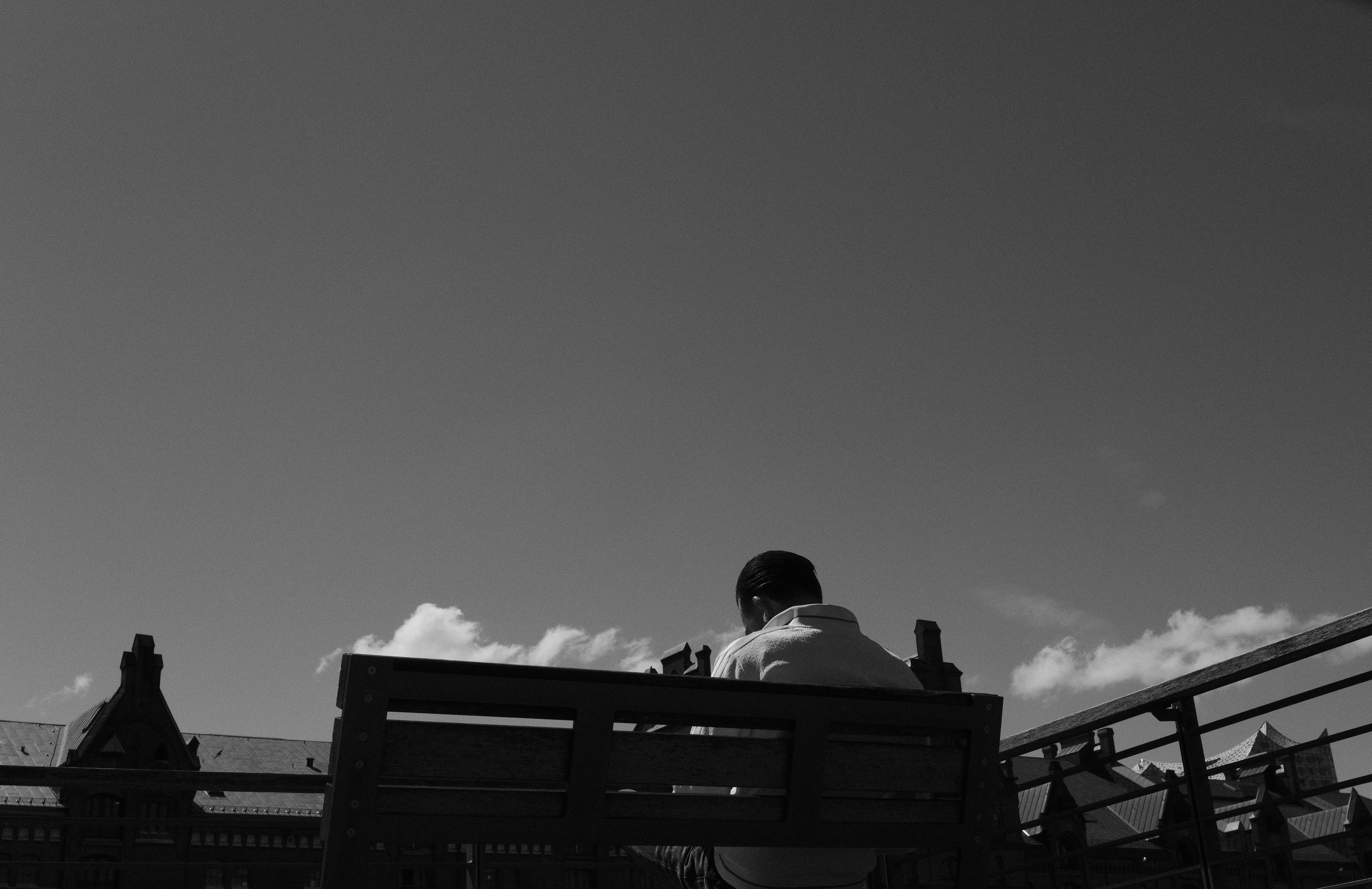 Silhouette on the Bench: Quiet Horizon Above the City