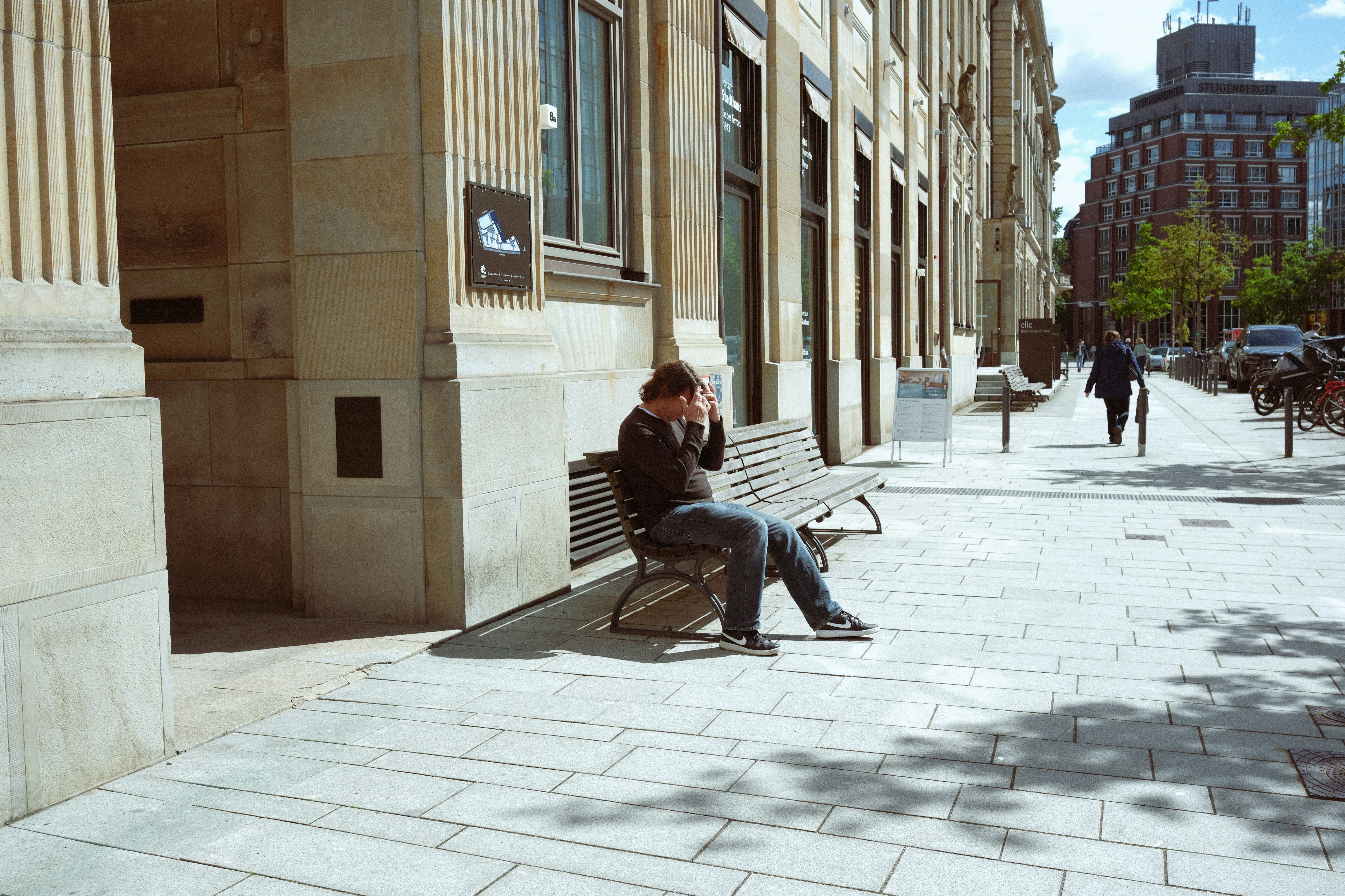 Lonely Reader on a Sunny City Street