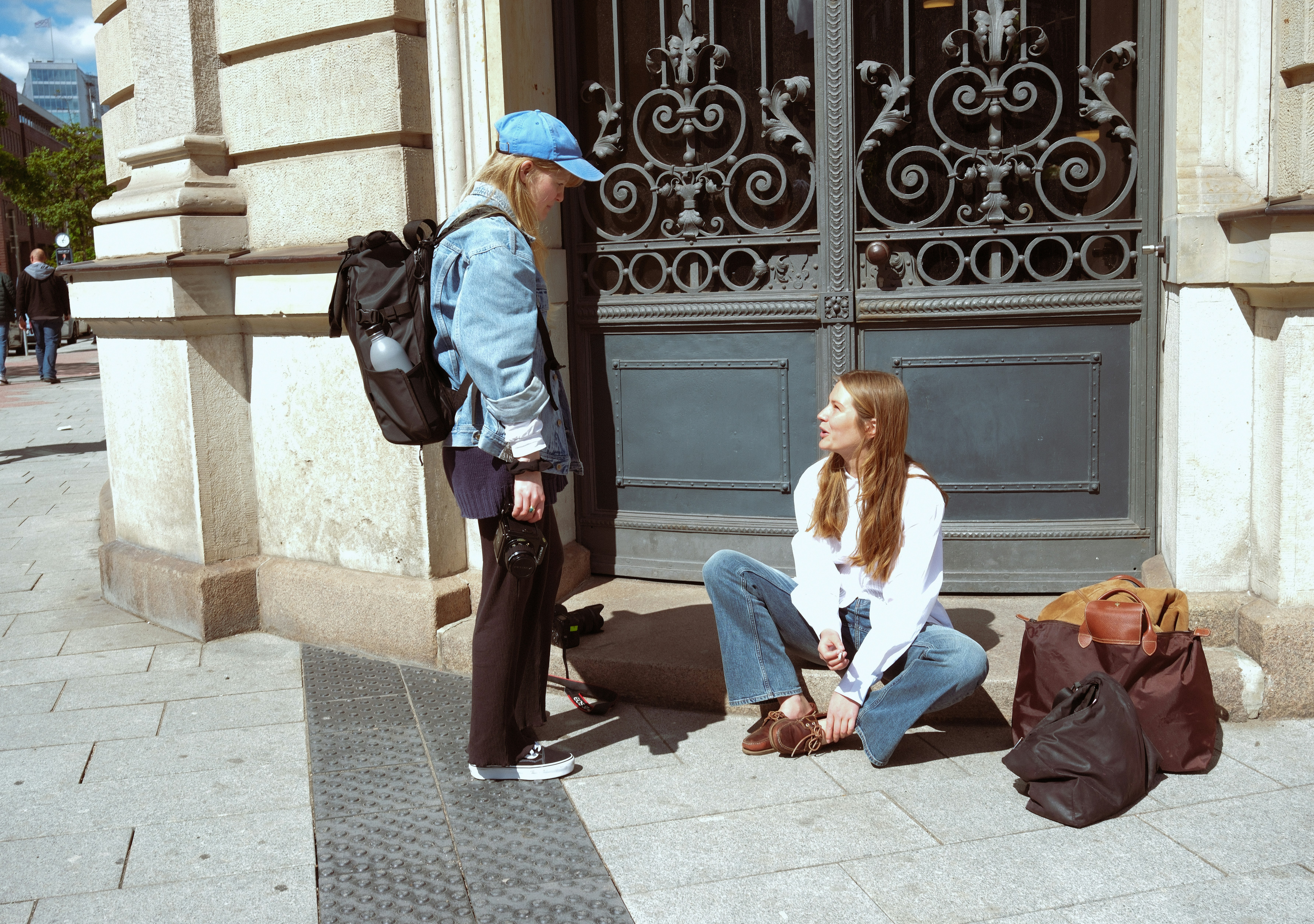 Conversation at the Pediment: Street scene with a kneeling companion