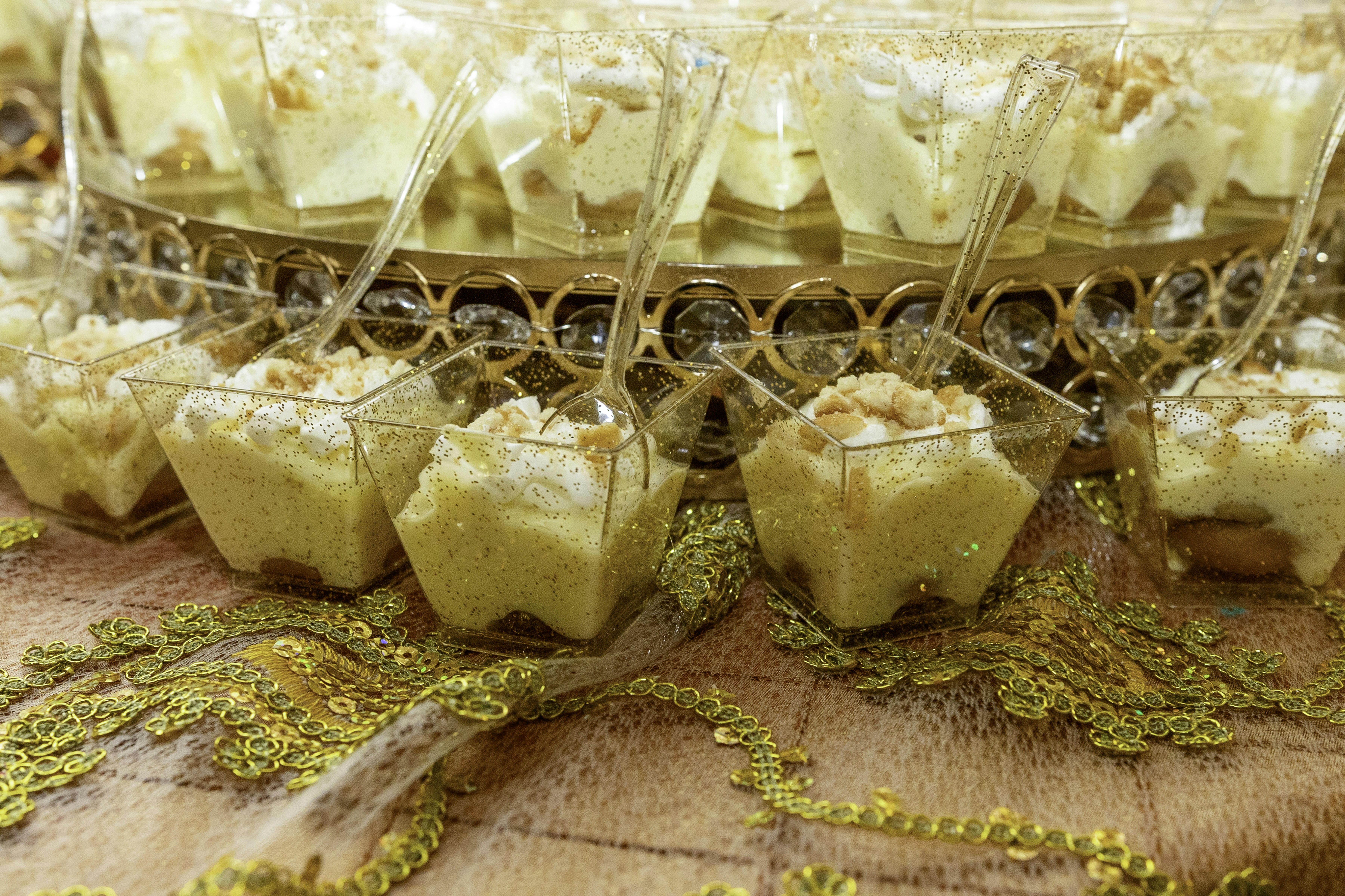 Golden bite-sized desserts on ornate veil of lace