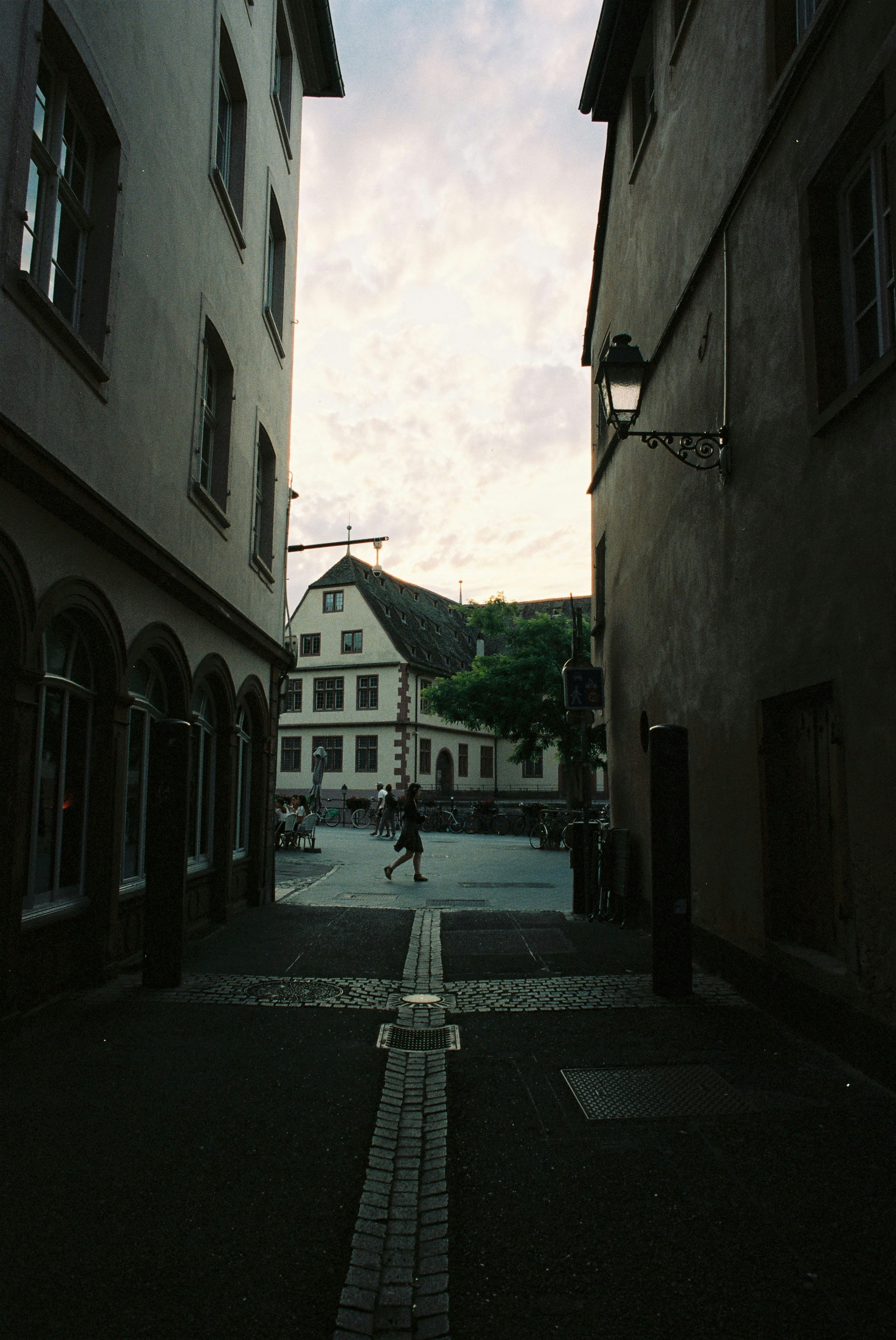 Narrow Alley Transitions to Open Square at Dusk