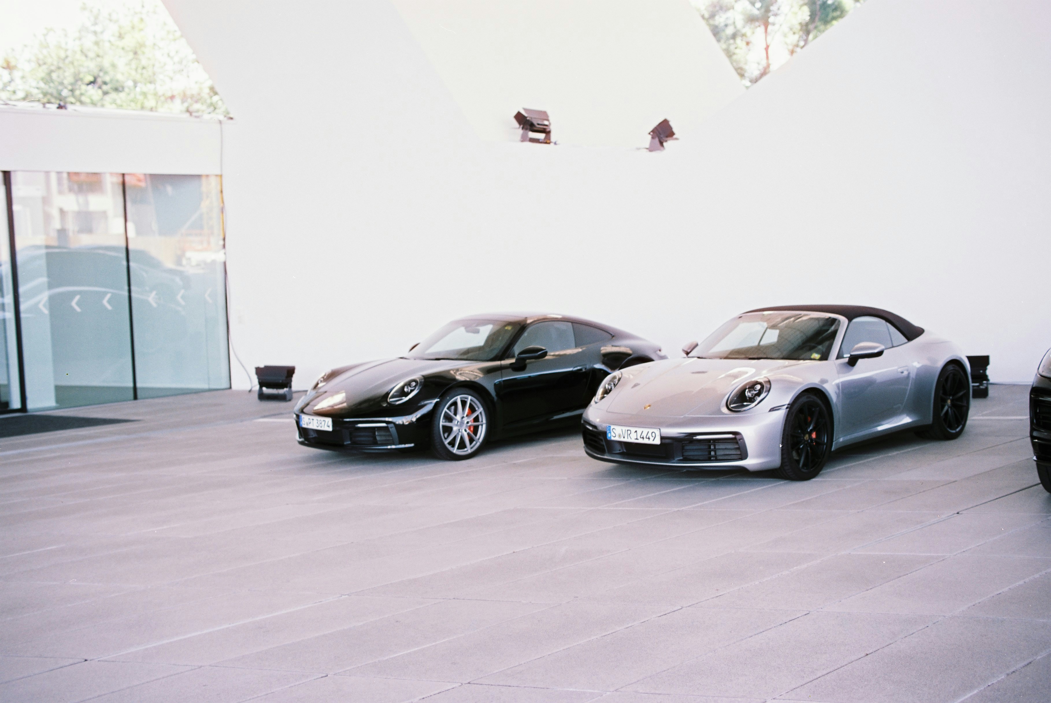 Dual Portolano: A Pair of Porsches Rest on a Minimal Terrace