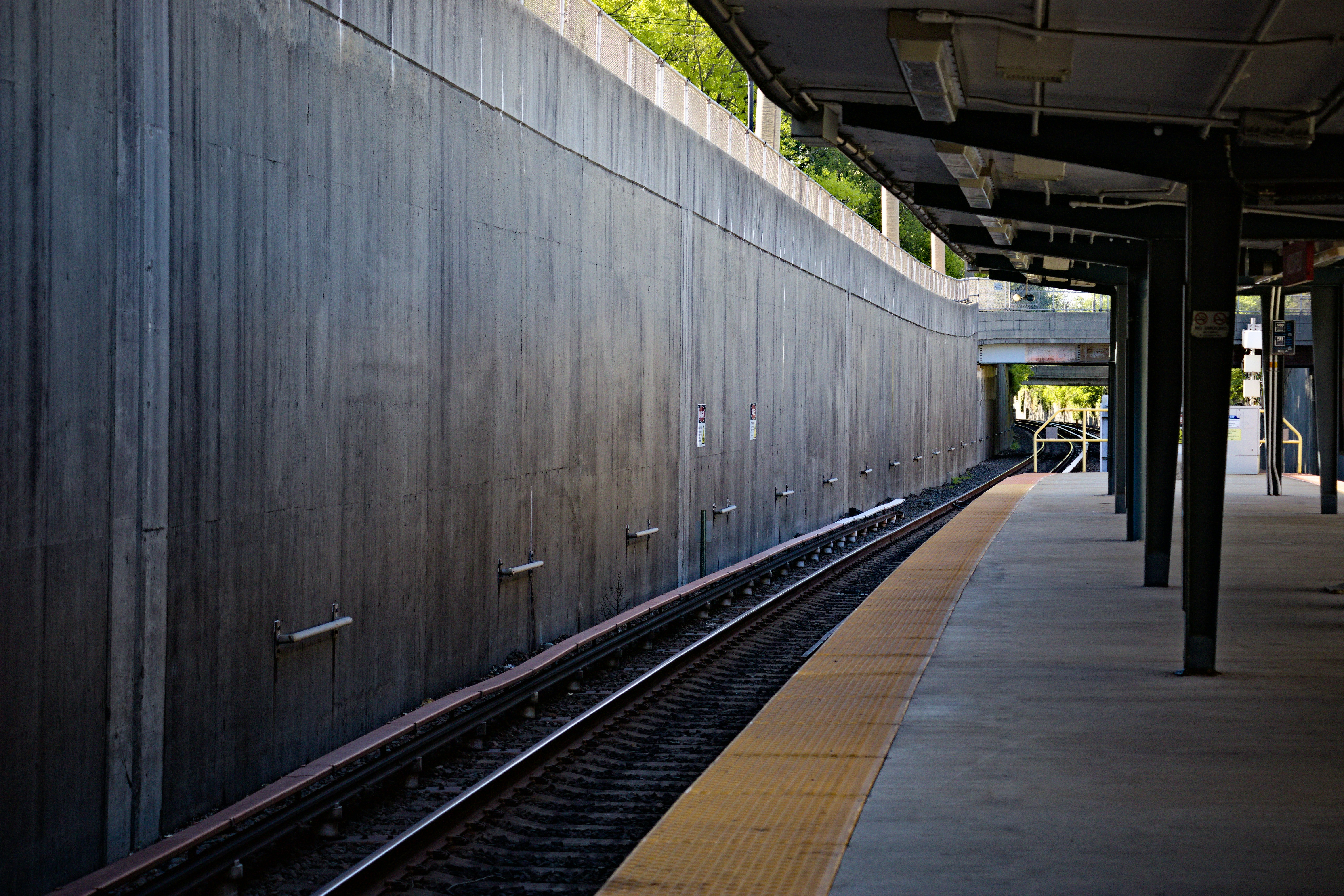 Converging Rails under a Quiet Platform Roof