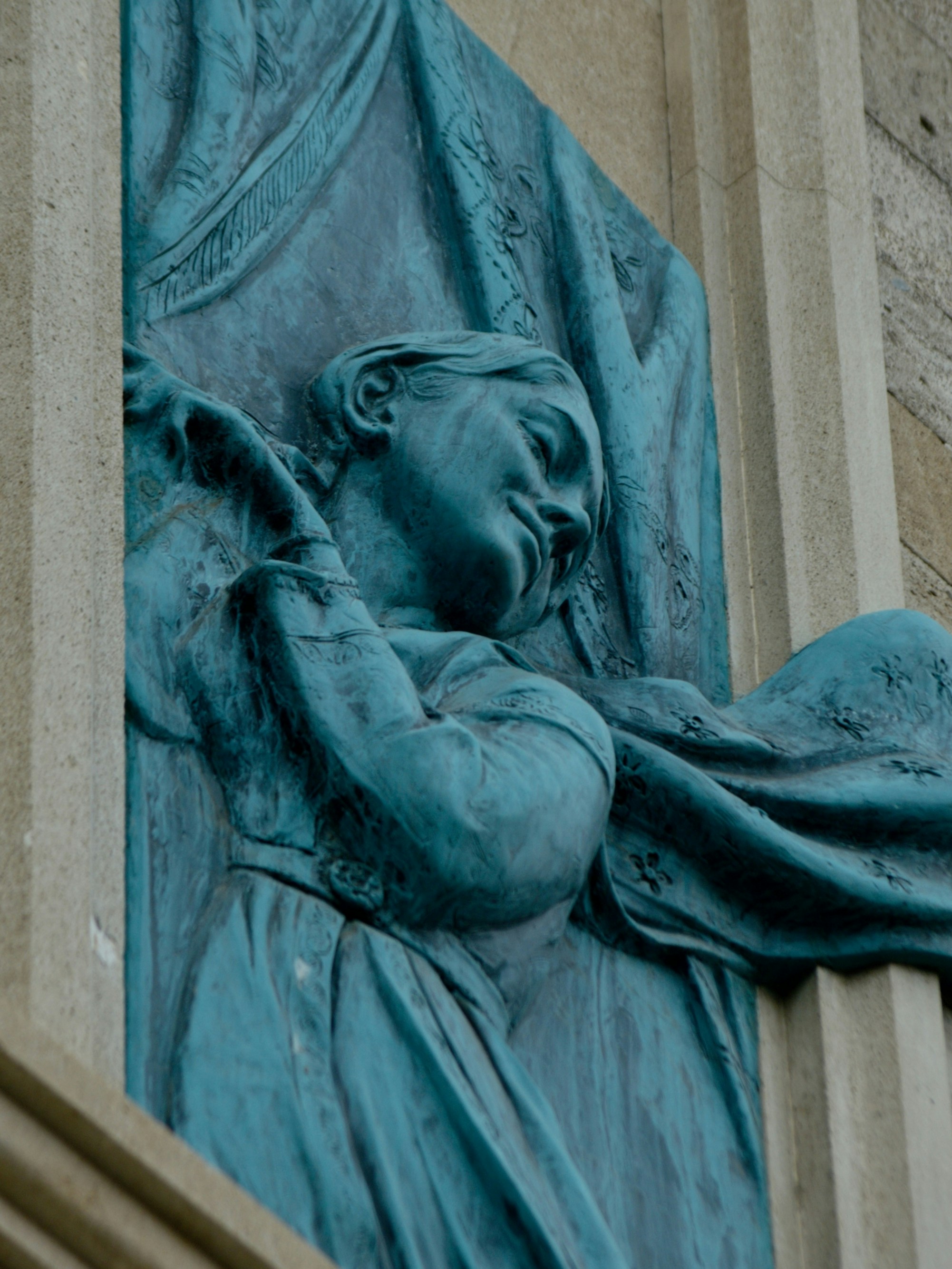Carved guardian with a serene gaze winds around stone architecture