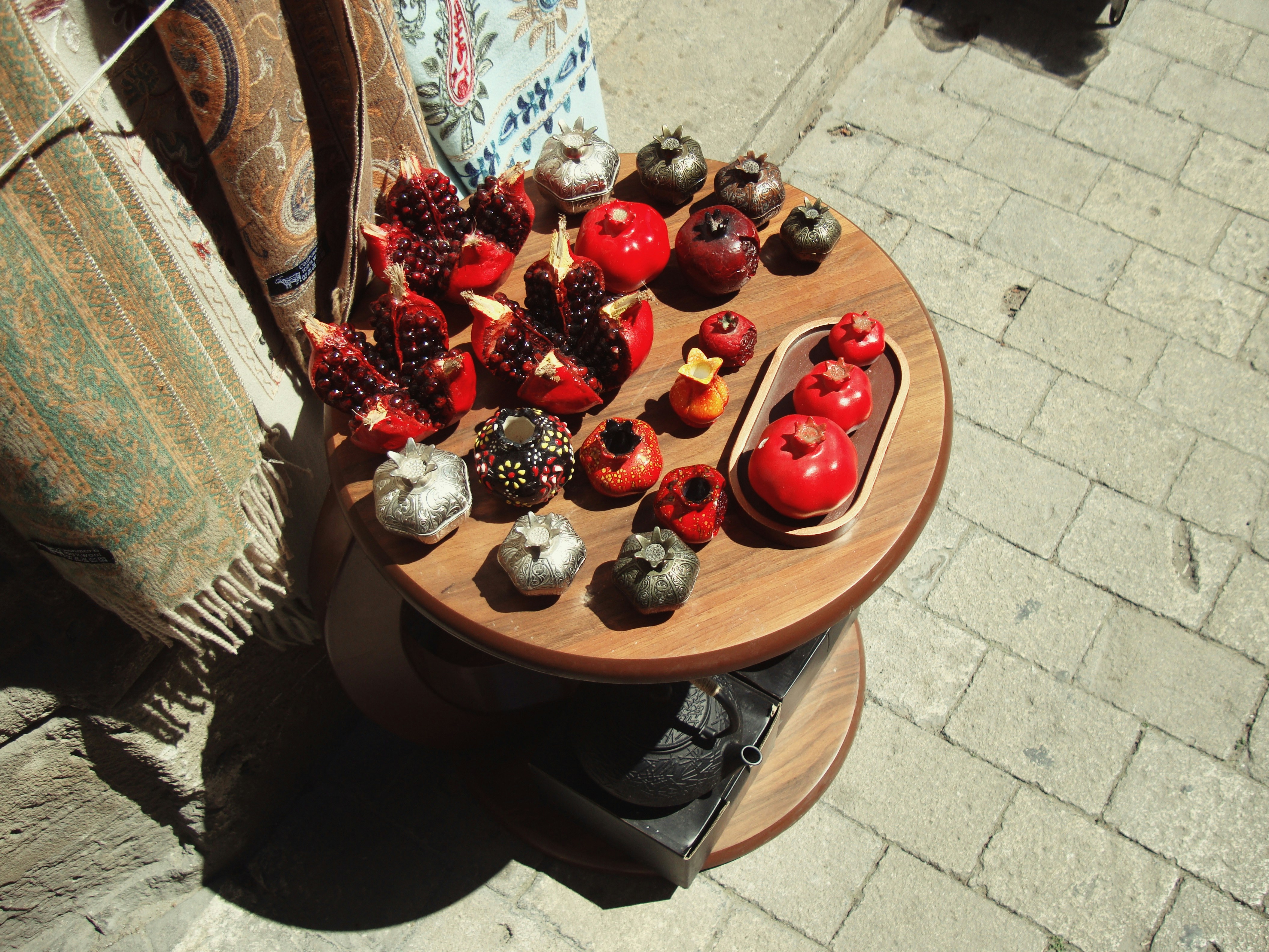 Street-side Sweetness: A Carousel of Mini Desserts on a Wooden Pedestal