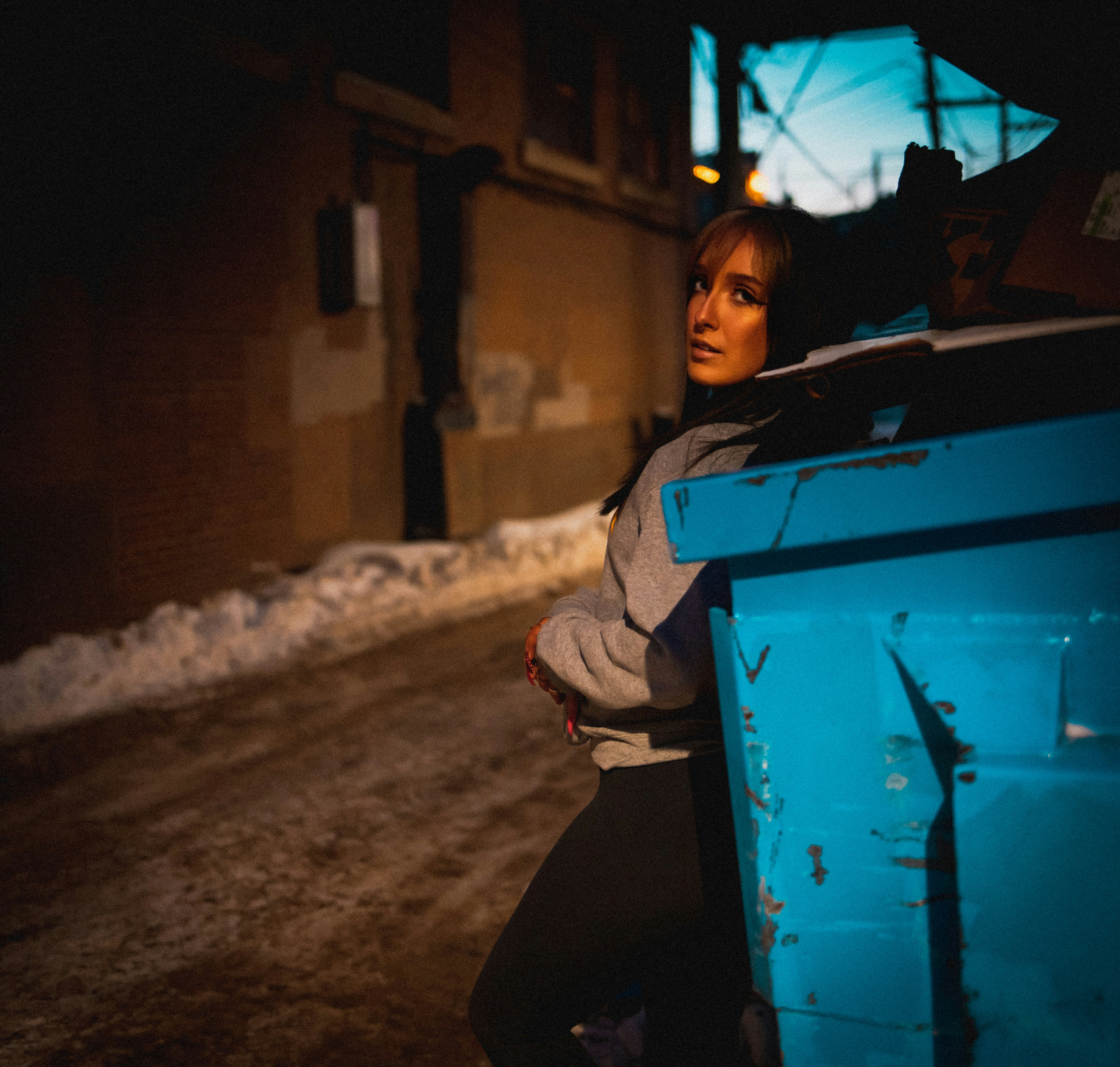 Leaned Against the Blue Dumpster: Night Portrait by a Narrow Alley