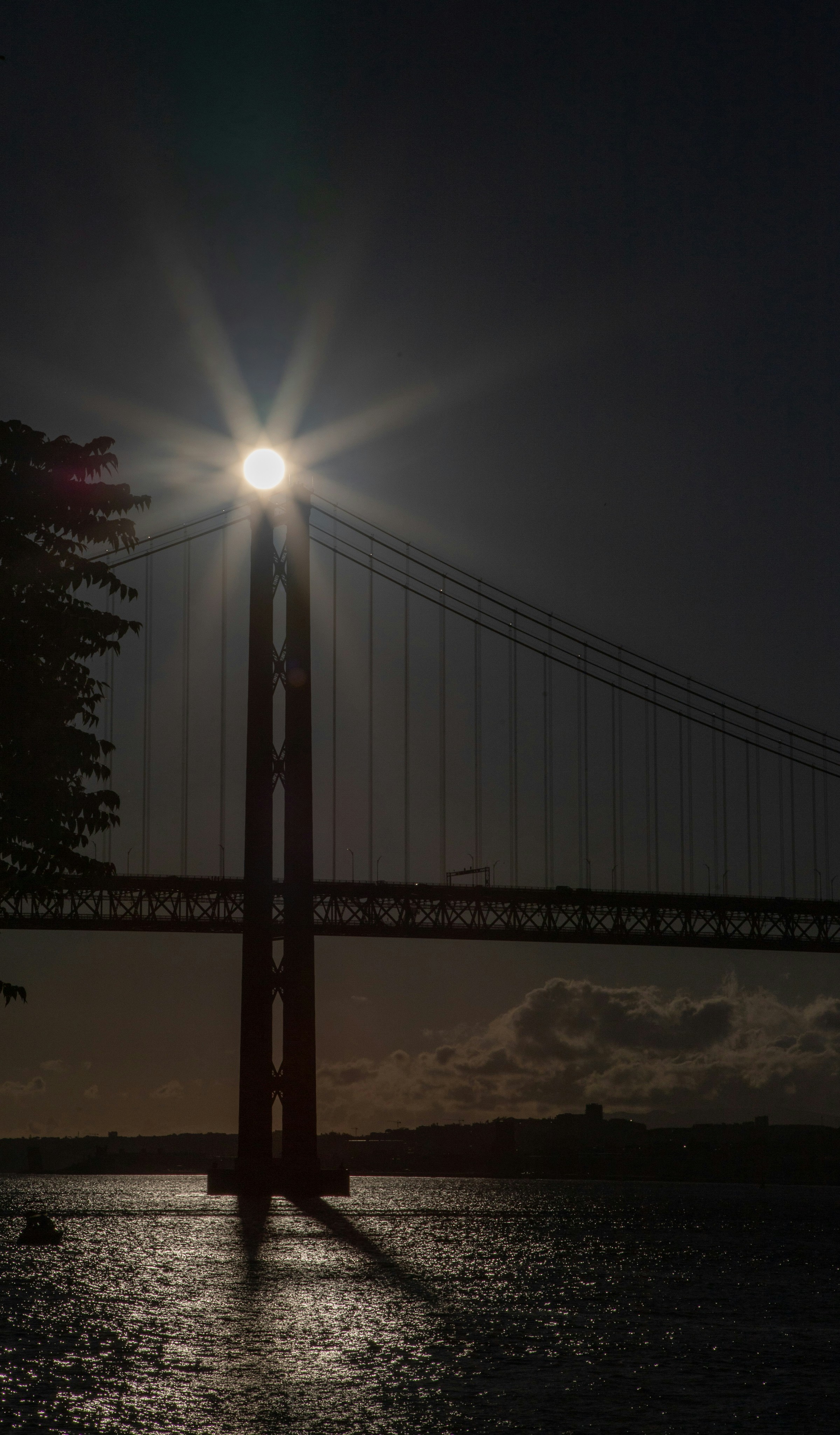 Nighttime Suspension: Sunburst on a River Bridge